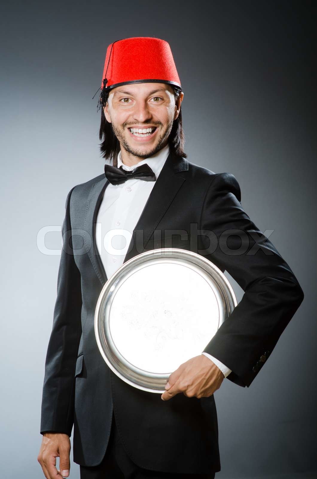 Waiter wearing traditional turkish hat | Stock image | Colourbox