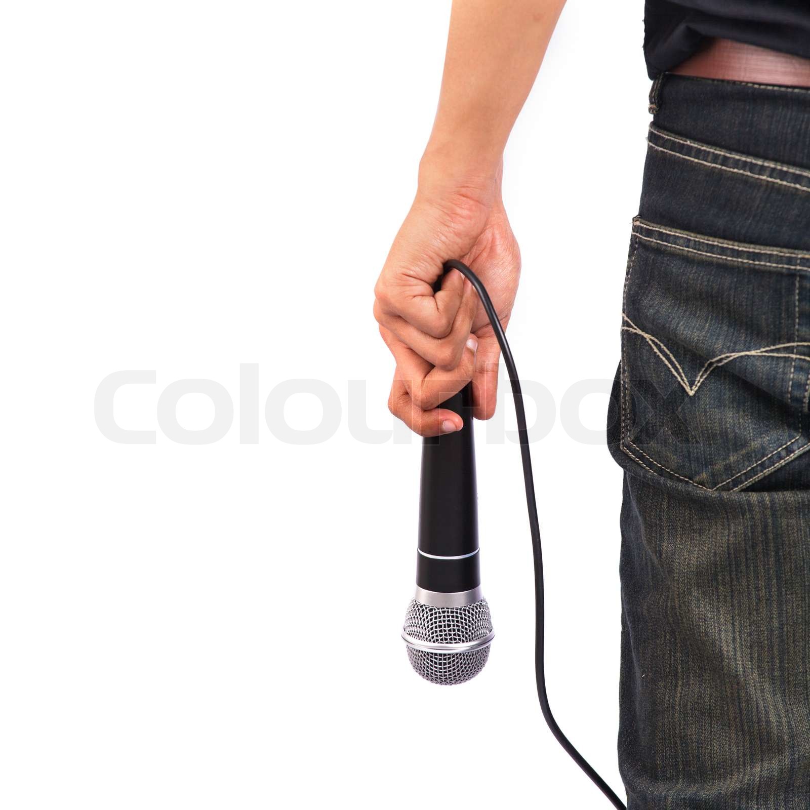 Male hand holding microphone | Stock image | Colourbox