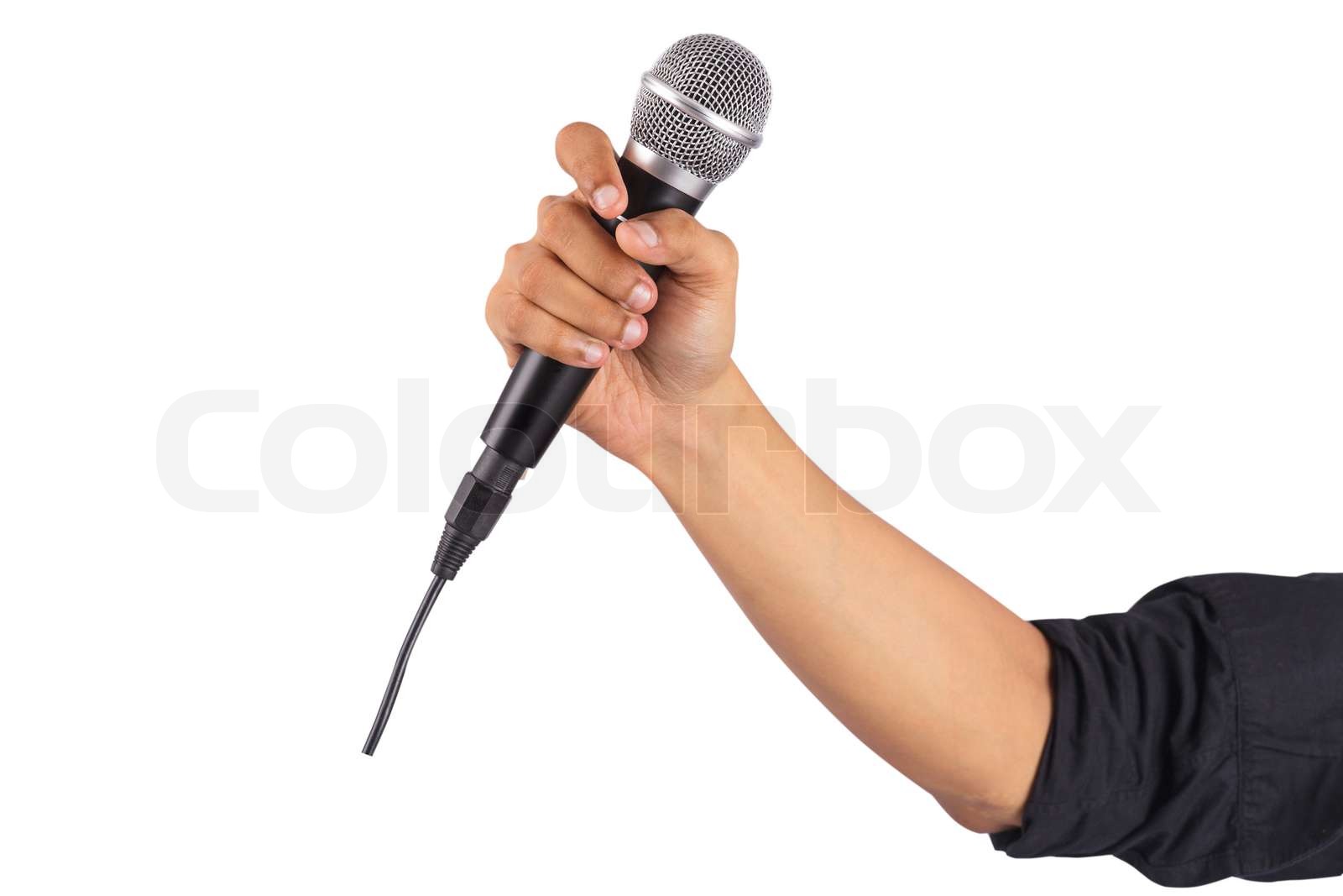Male hand holding microphone | Stock image | Colourbox