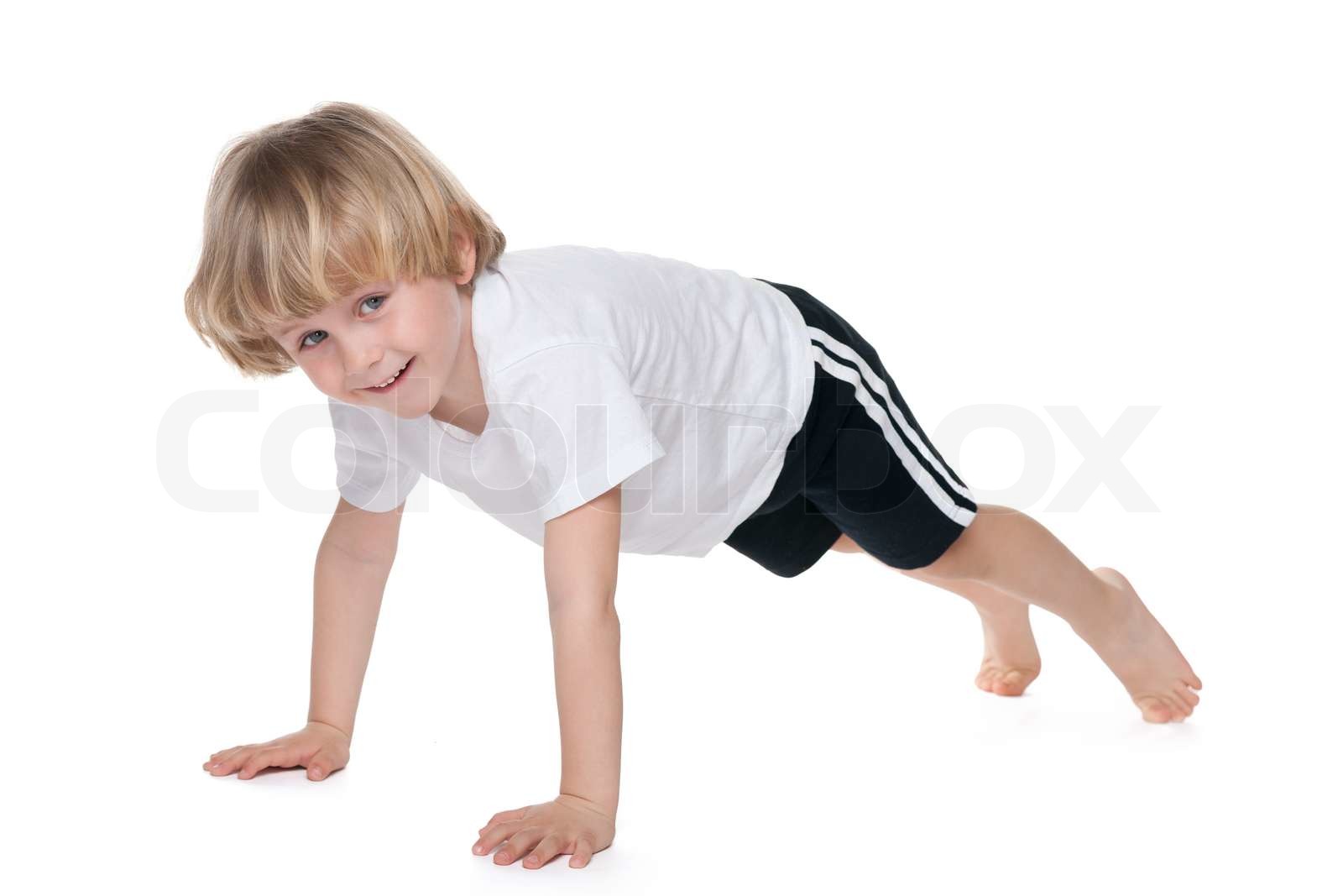 Cute boy performs gymnastic exercises | Stock image | Colourbox