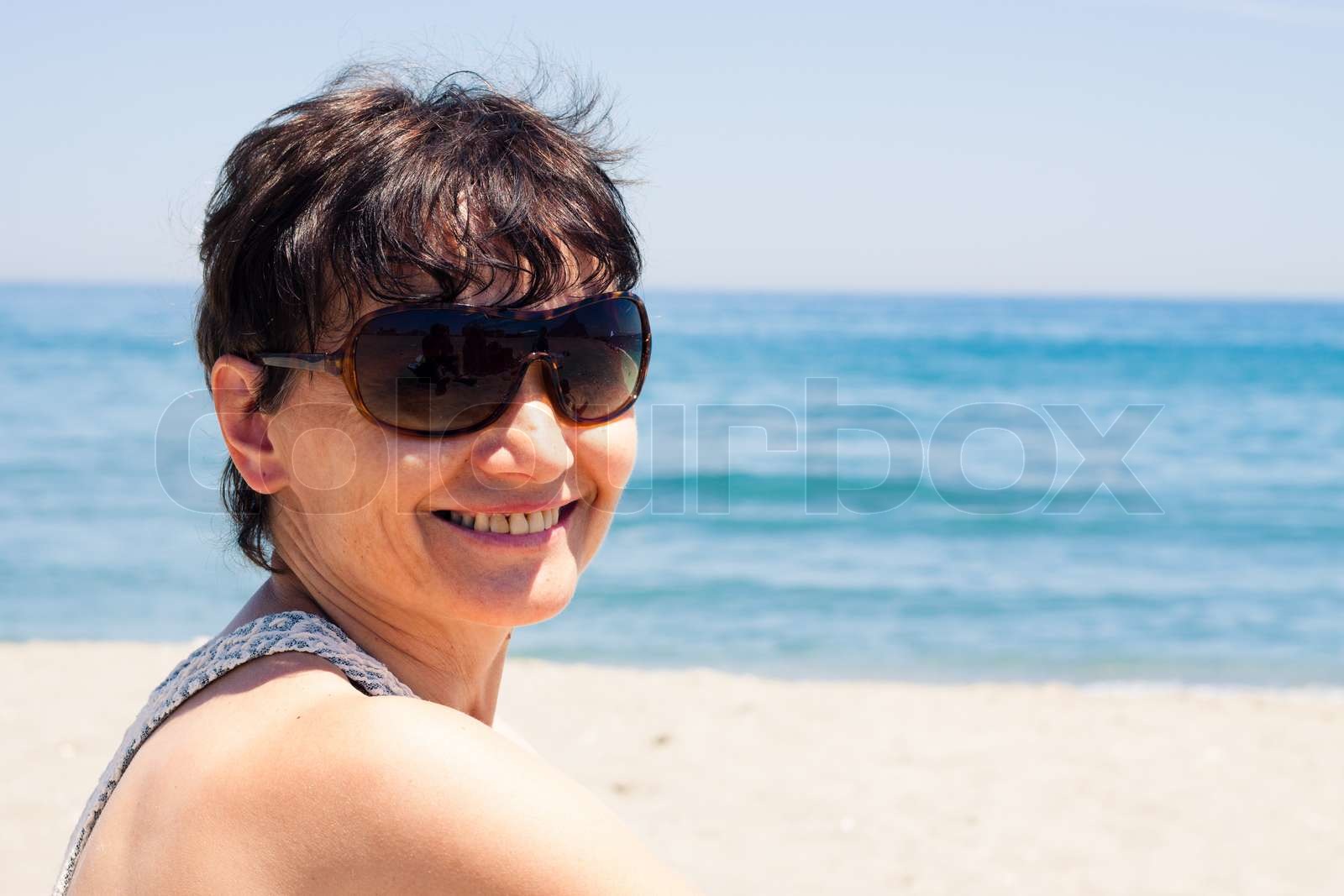 Happy middle aged woman on the beach | Stock image | Colourbox