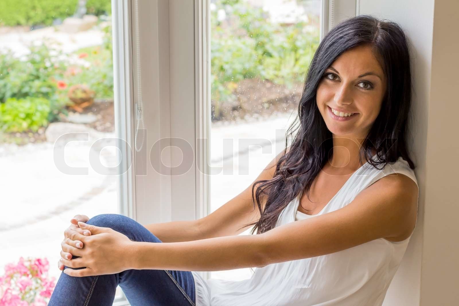 woman sitting on window | Stock image | Colourbox