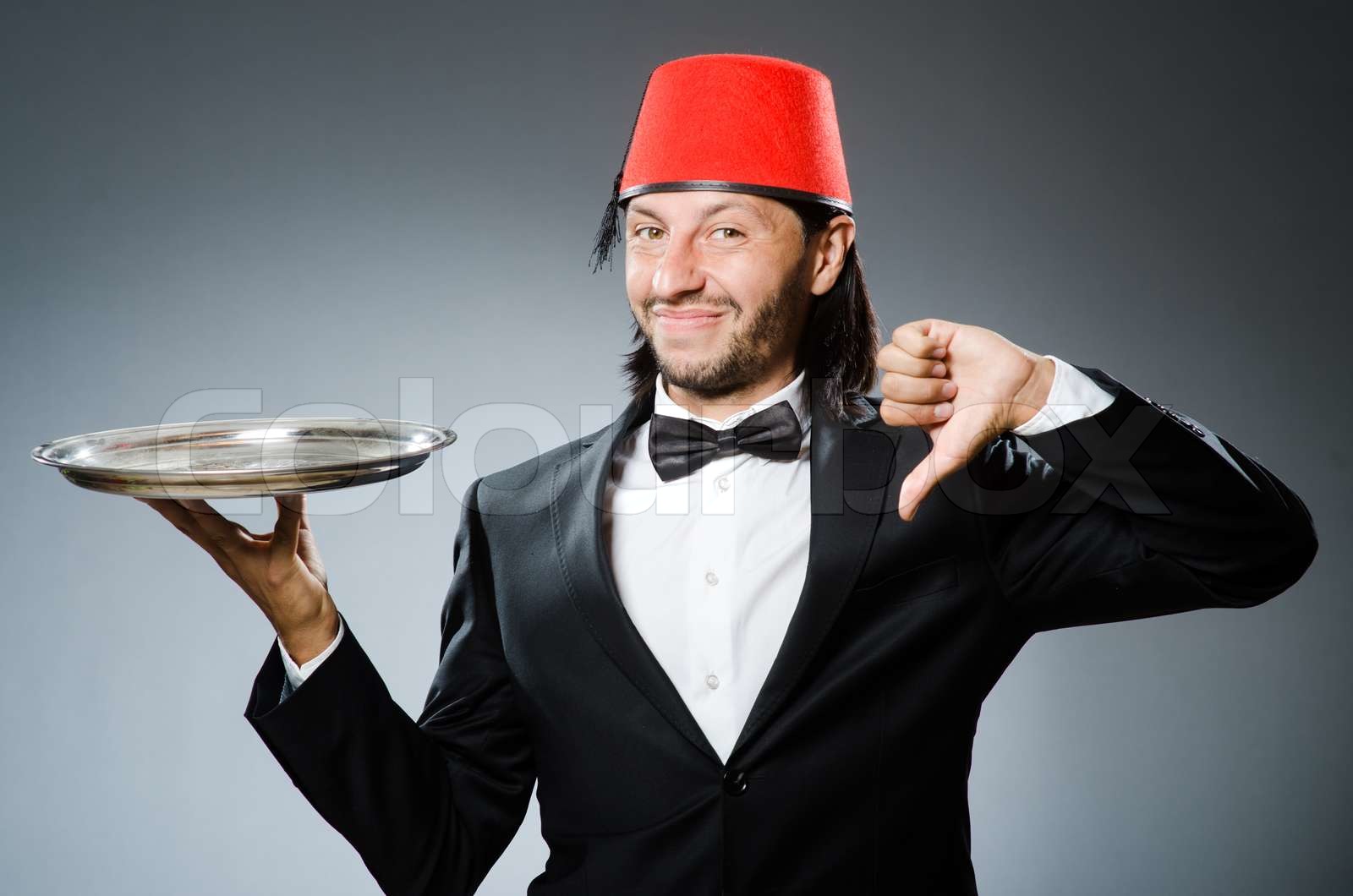 Waiter wearing traditional turkish hat | Stock image | Colourbox