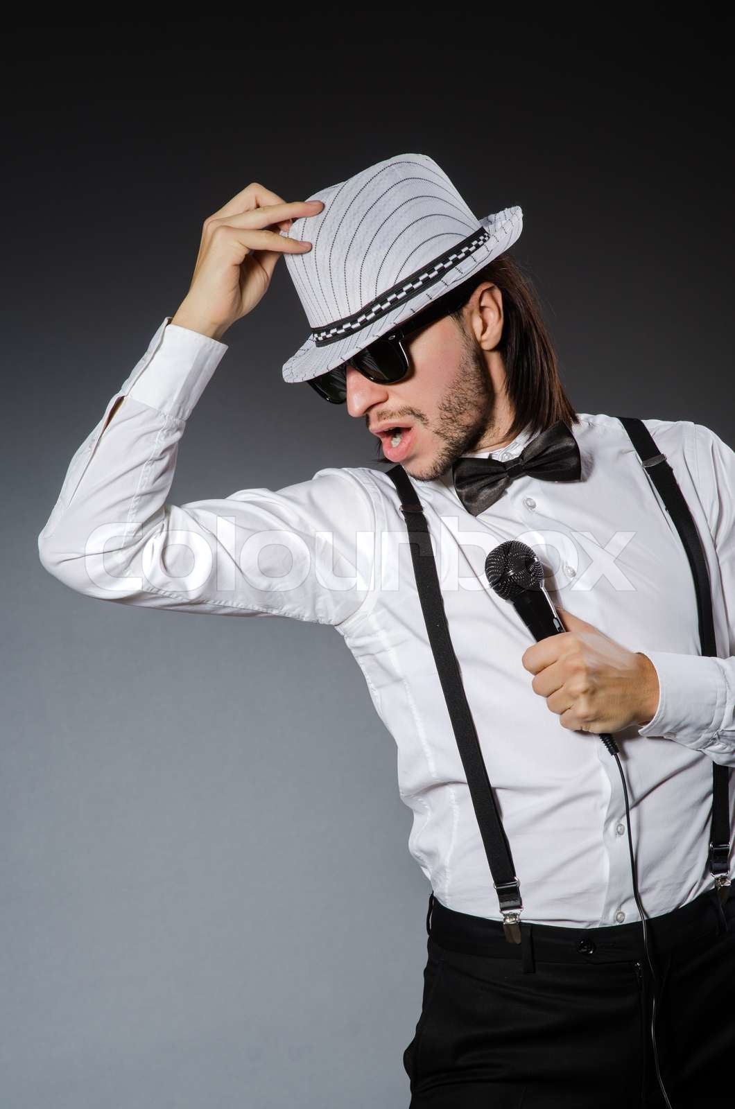 Funny singer with microphone at the concert | Stock image | Colourbox