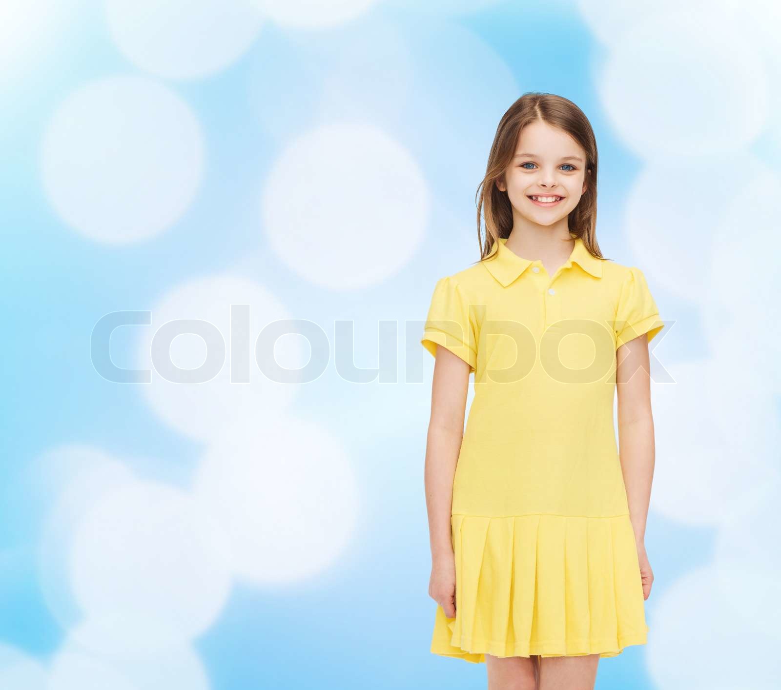 smiling little girl in yellow dress | Stock image | Colourbox
