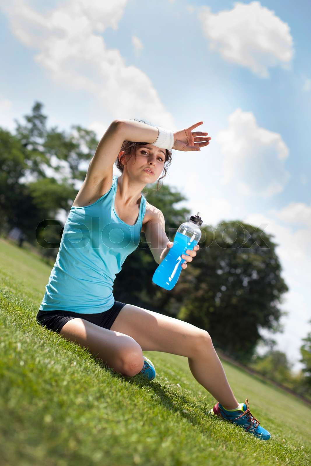 Tired woman runner taking a rest after run | Stock image | Colourbox