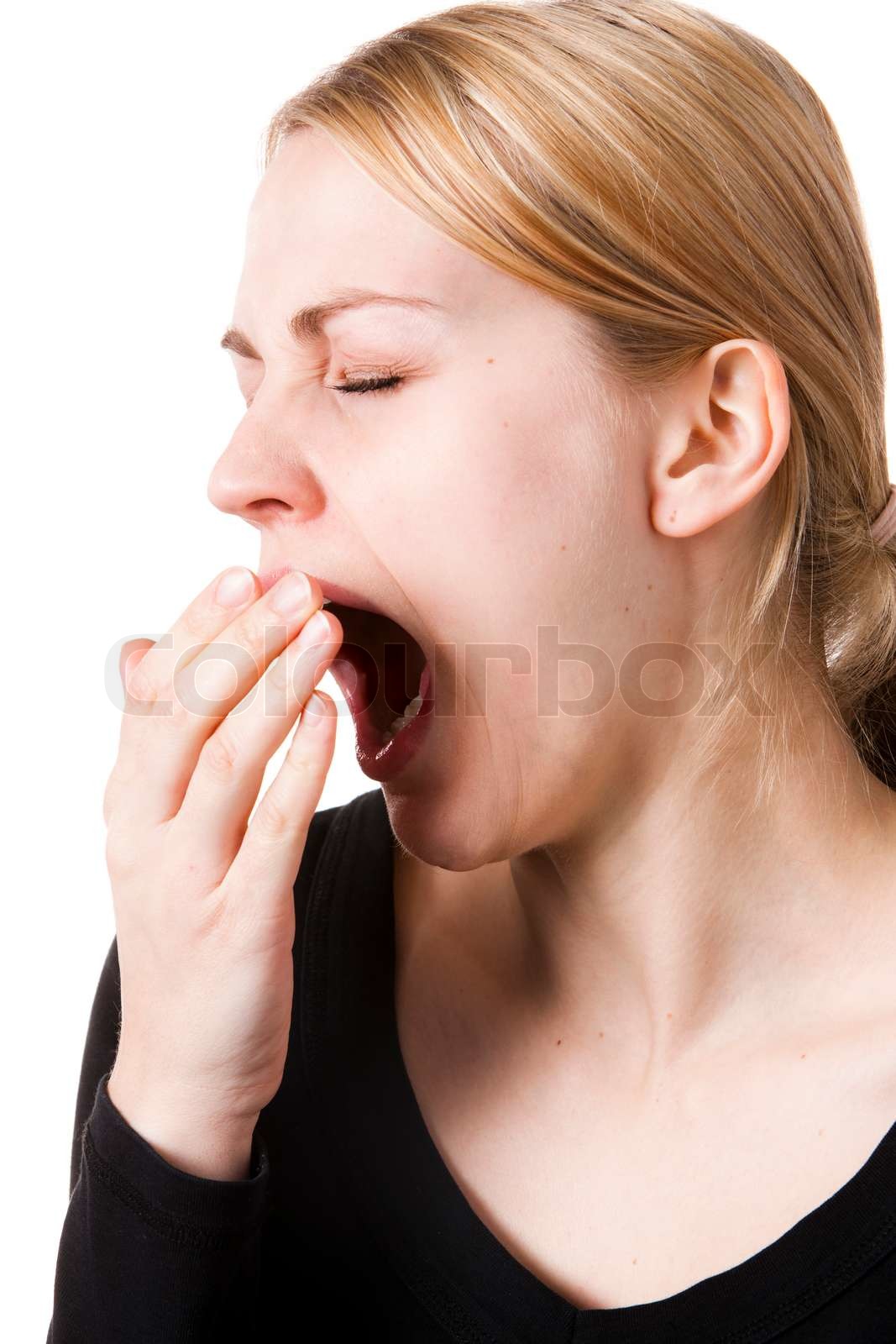 Portrait - blond woman yawning | Stock image | Colourbox