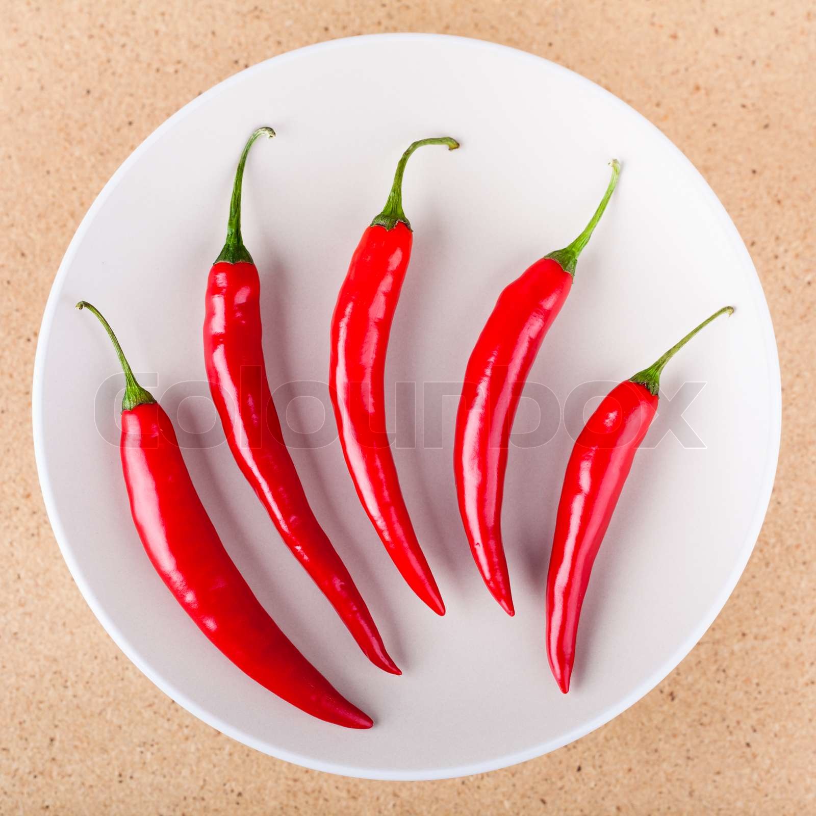 Fresh chili peppers on plate | Stock image | Colourbox
