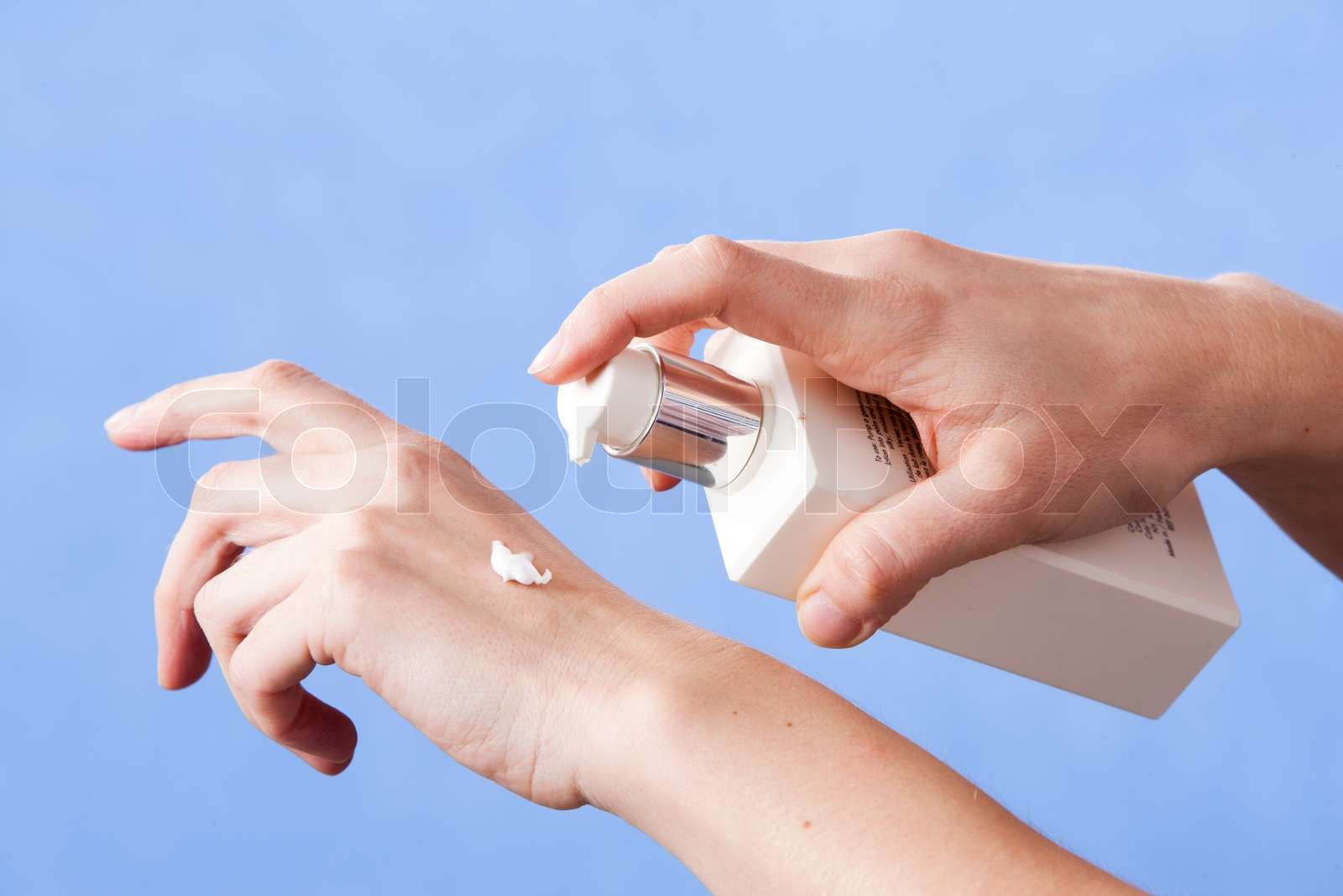 Applying lotion on hands | Stock image | Colourbox