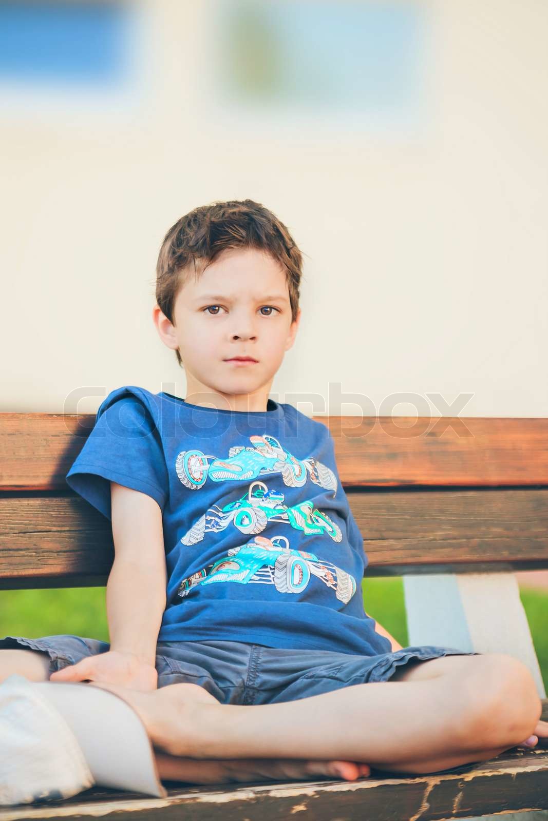 sad boy sitting on a bench | Stock image | Colourbox