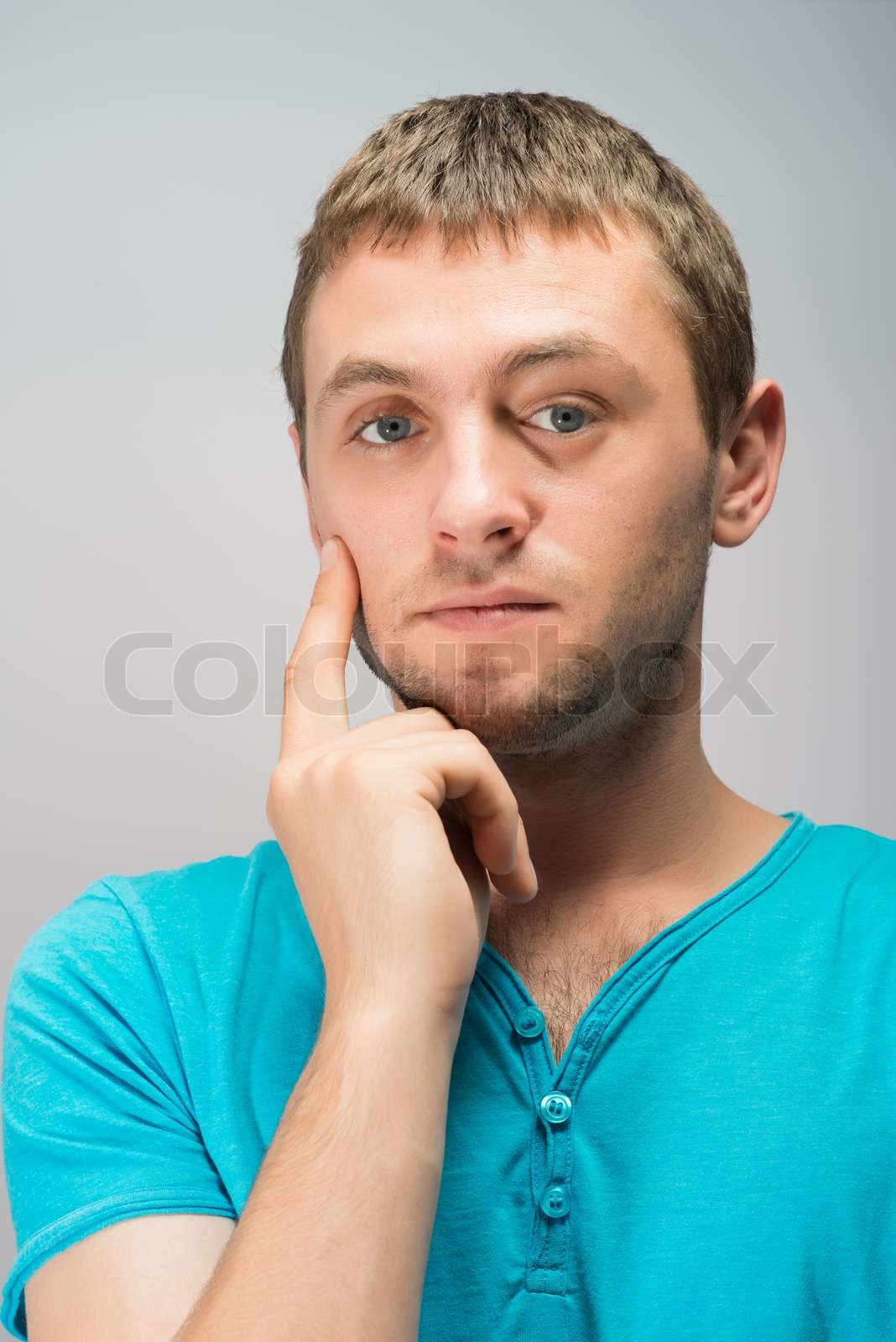 Portrait of a young businessman holding his chin with his hand. | Stock ...