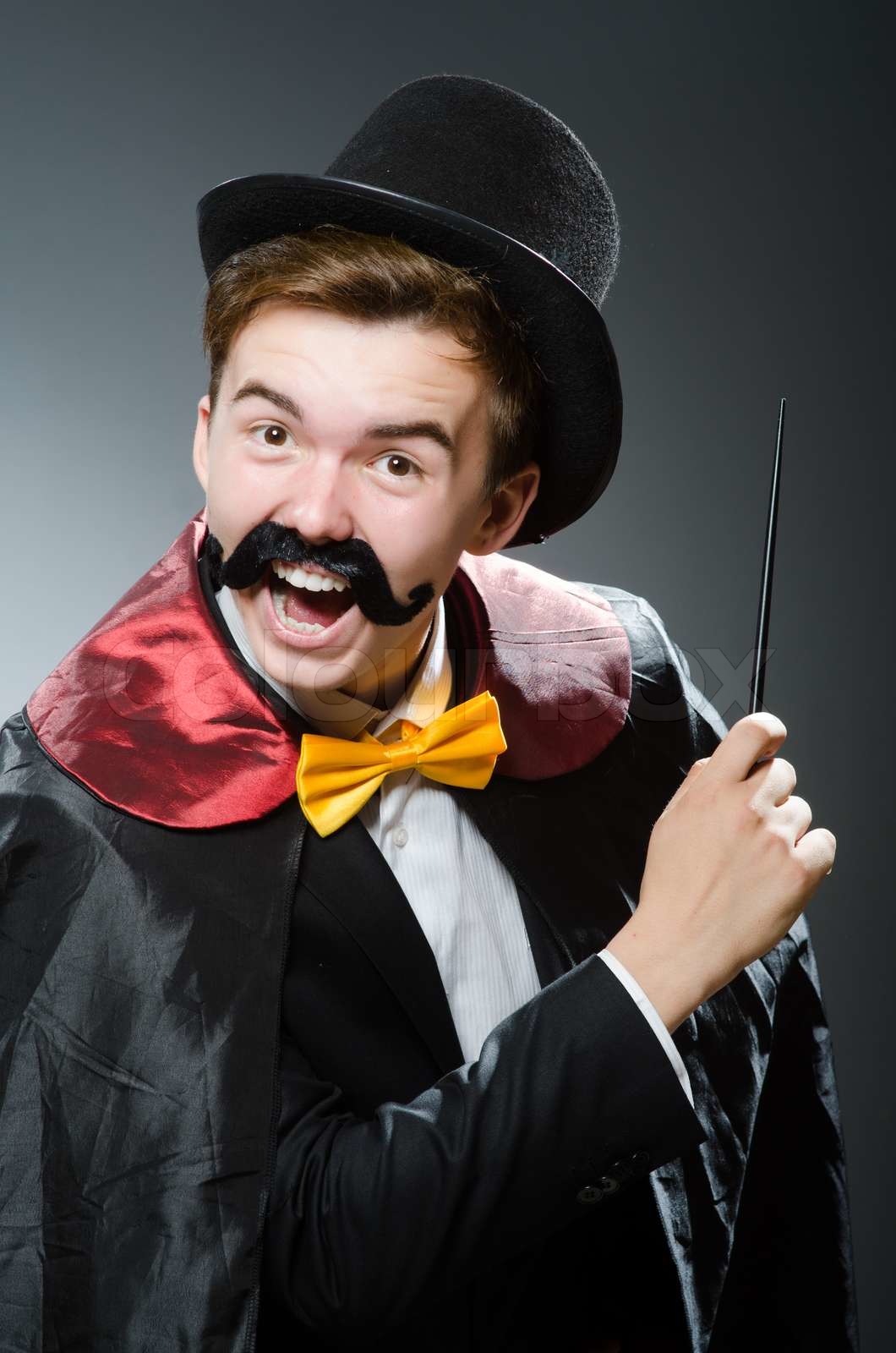 Funny magician with wand and hat | Stock image | Colourbox