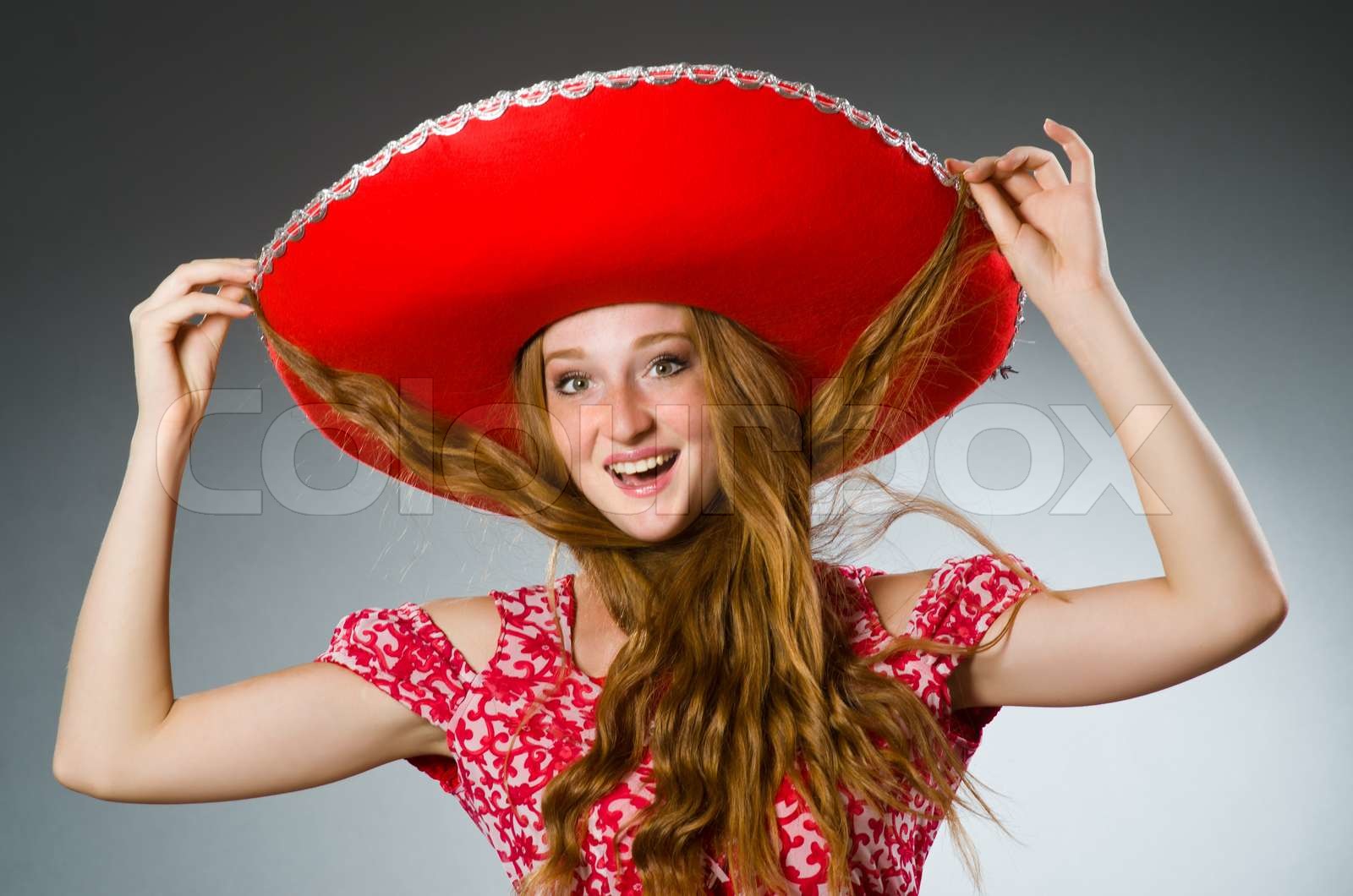 Mexican woman wearing red sombrero | Stock image | Colourbox