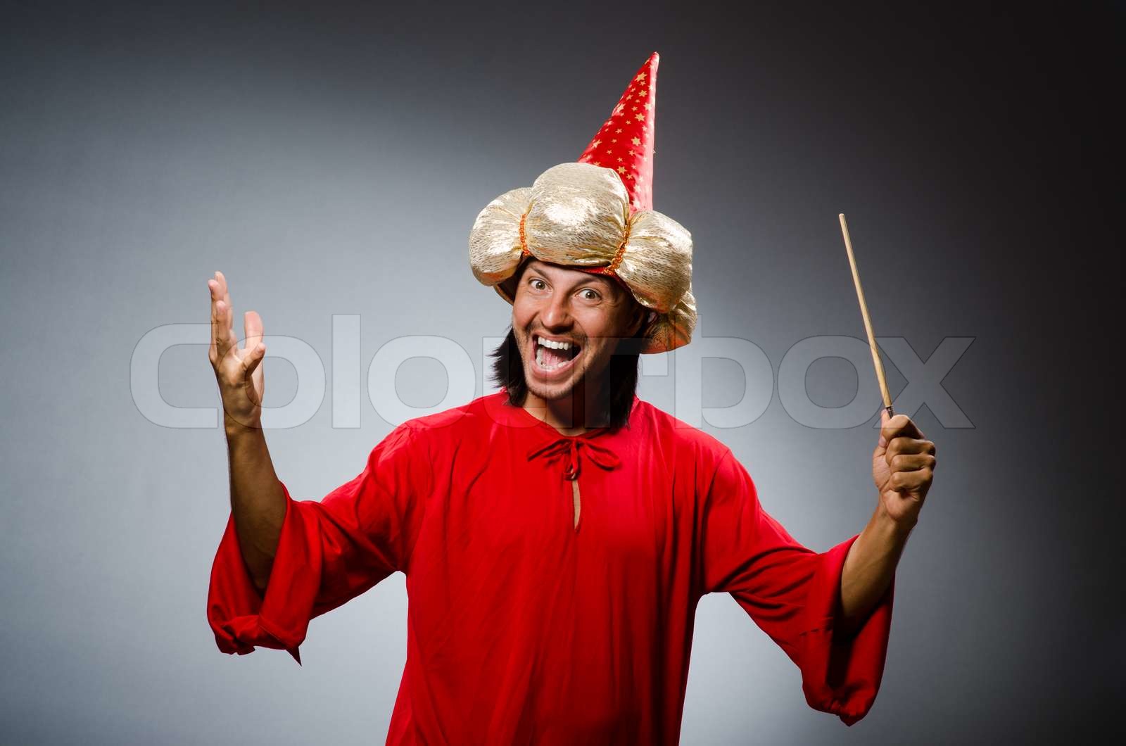 Funny wizard wearing red dress | Stock image | Colourbox