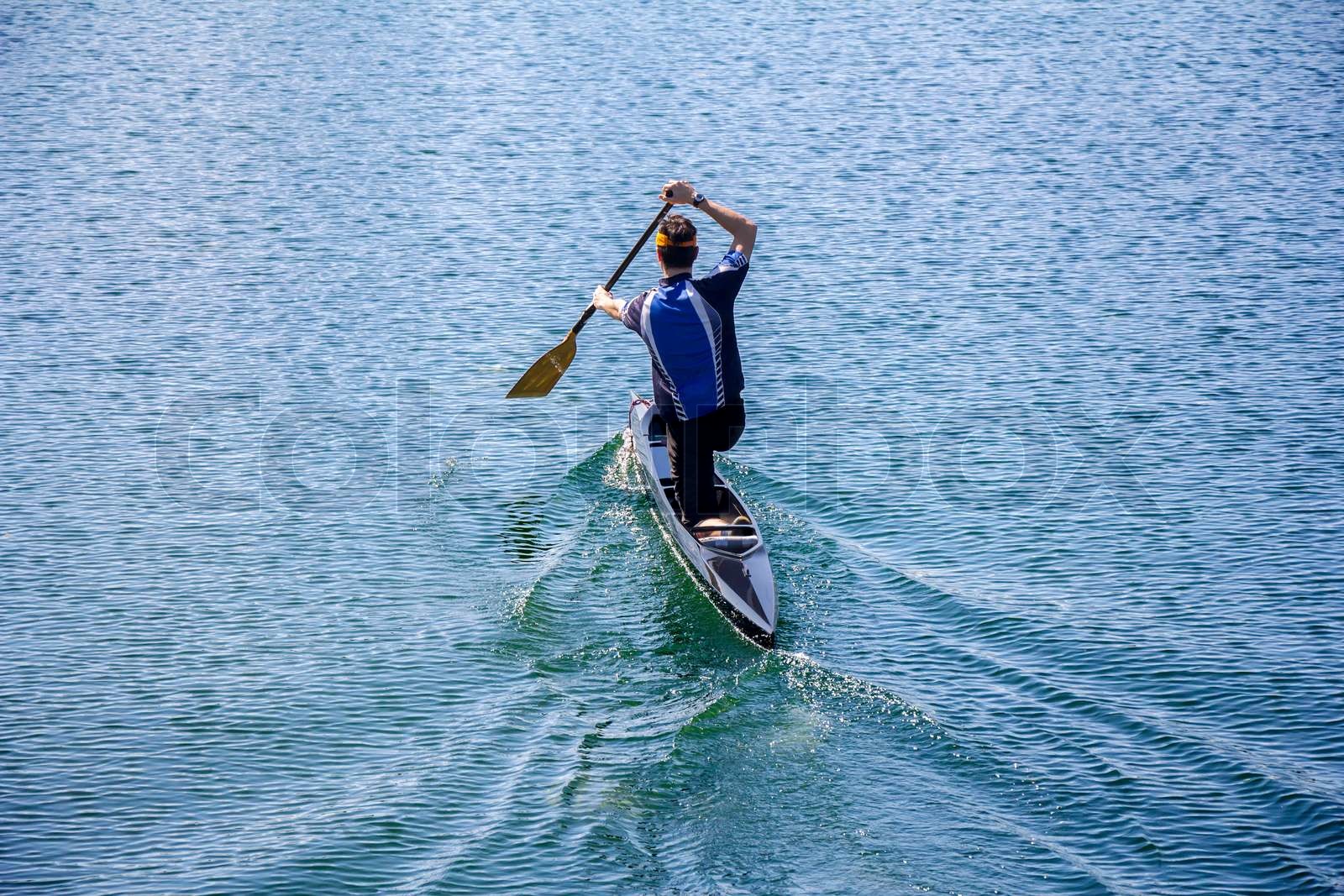 Man rowing in a canoe | Stock image | Colourbox