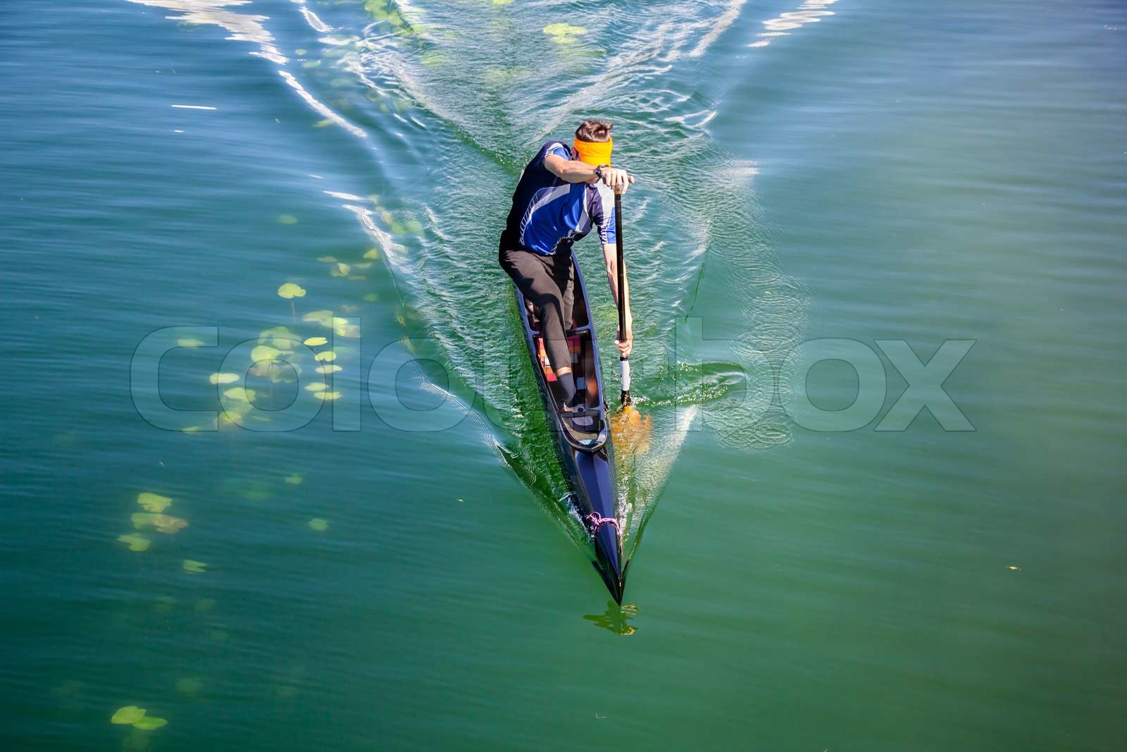 Man rowing in a canoe | Stock image | Colourbox