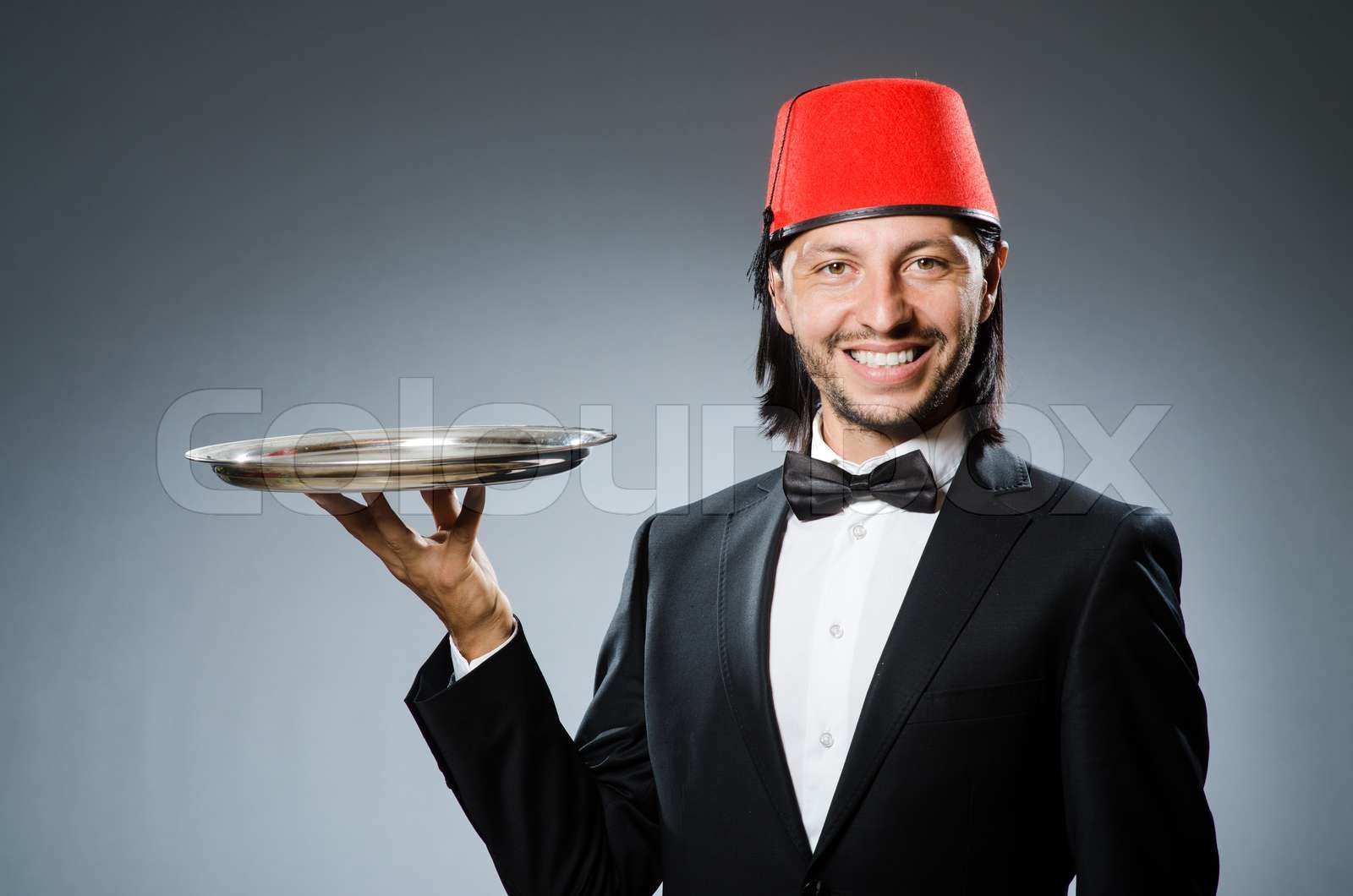 Waiter wearing traditional turkish hat | Stock image | Colourbox
