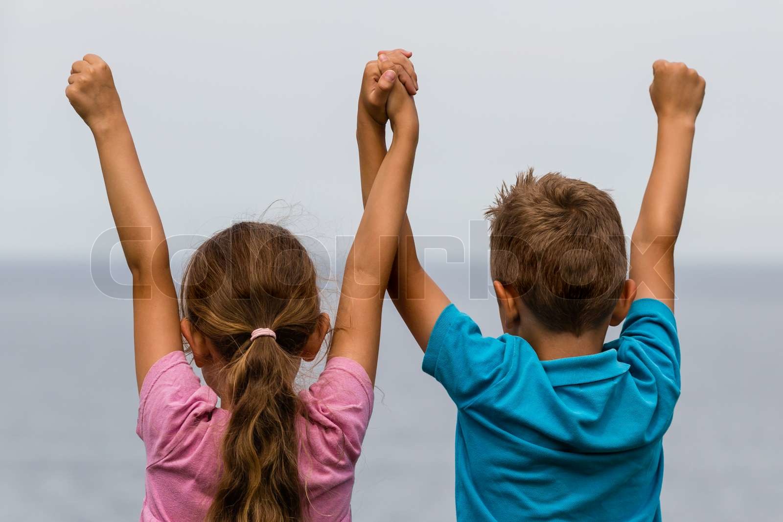 Kids with raised arms | Stock image | Colourbox