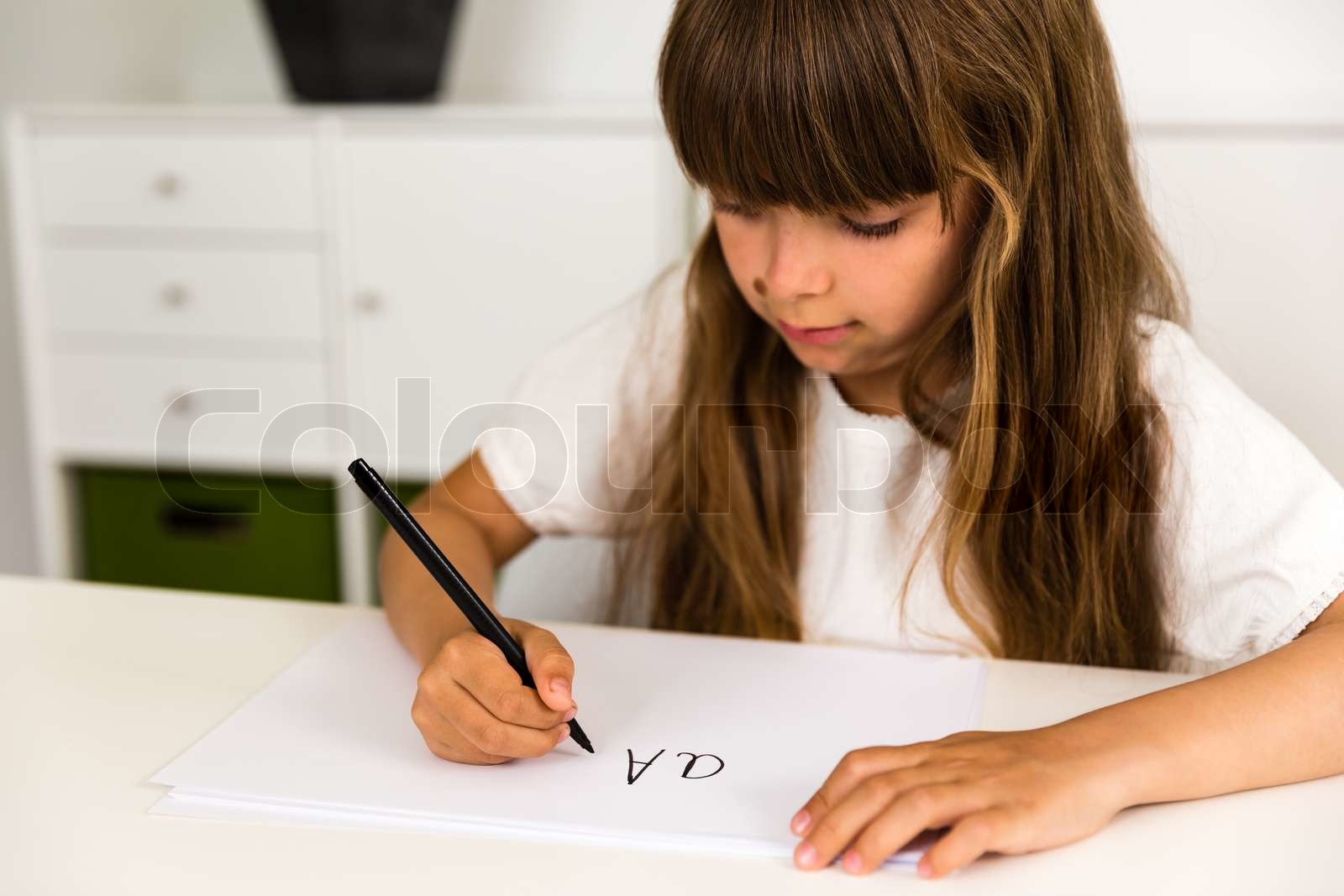 Girl writing the ABC alphabet | Stock image | Colourbox