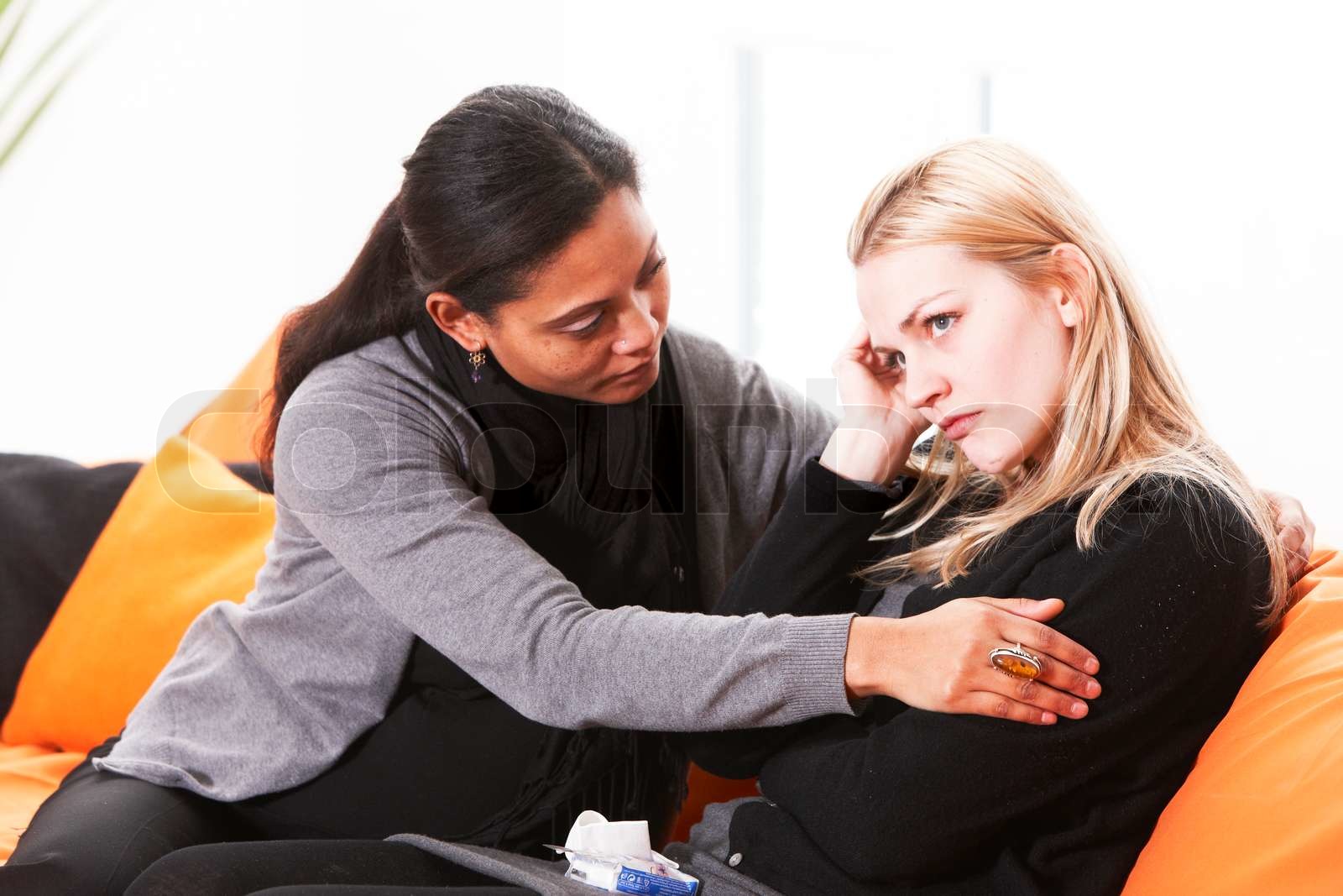 Two female friends consoling each other | Stock image | Colourbox