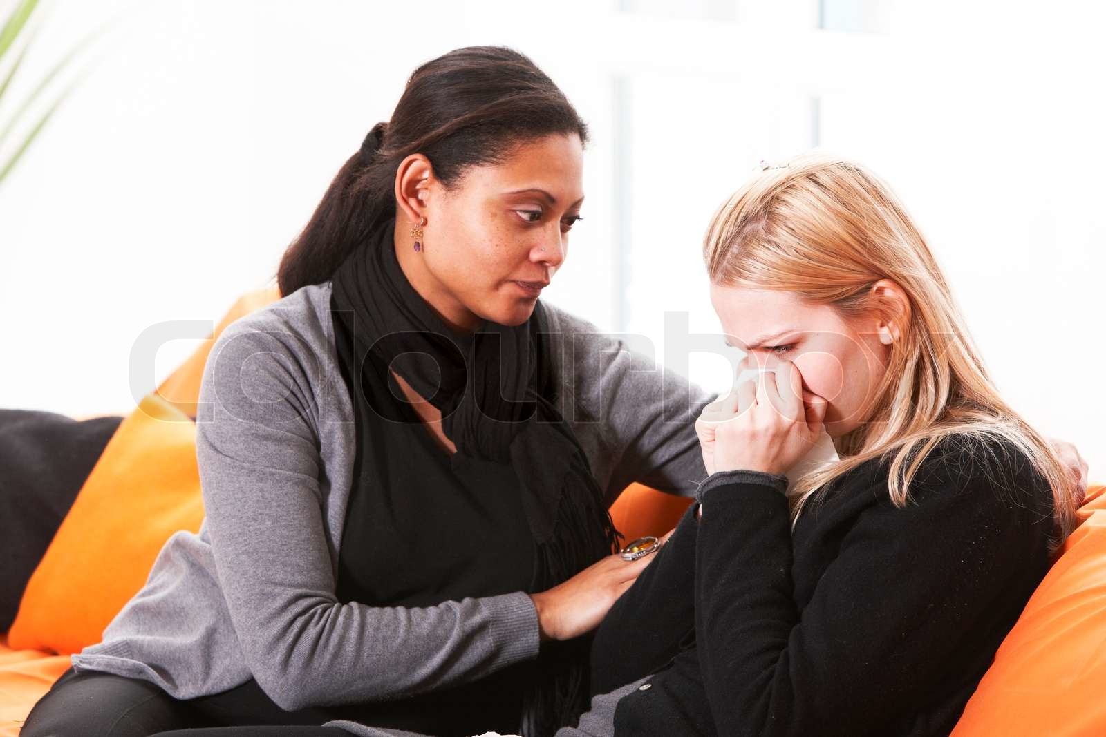 Two female friends consoling each other | Stock image | Colourbox