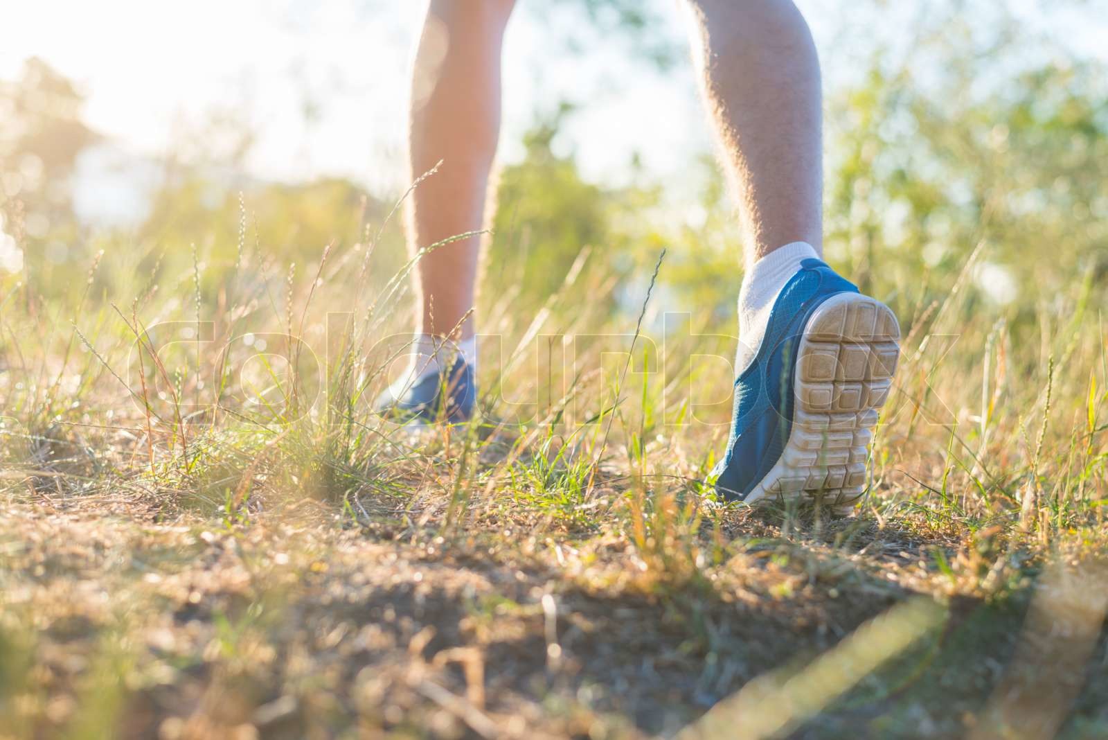 Athlete running in the sand feet | Stock image | Colourbox