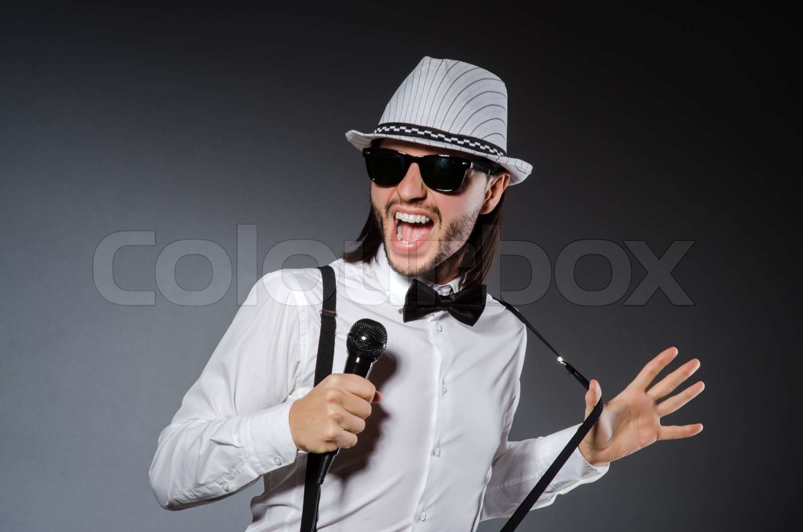 Funny singer with microphone at the concert | Stock image | Colourbox
