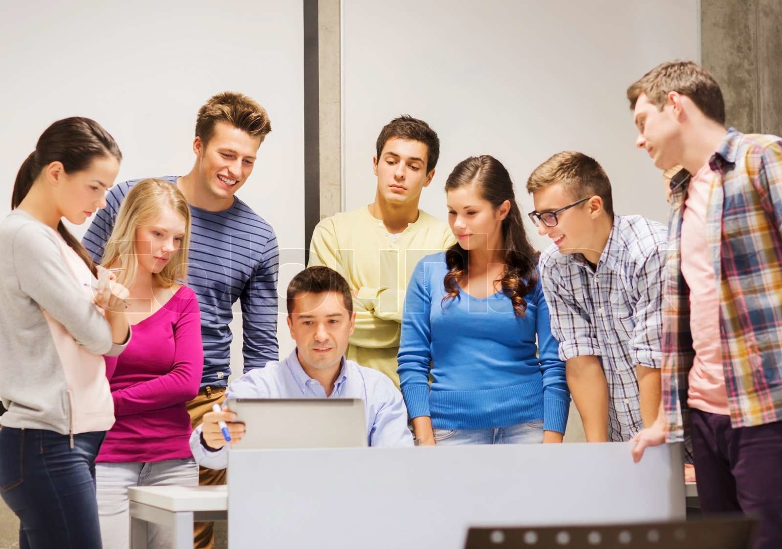 group of students and teacher with laptop | Stock image | Colourbox