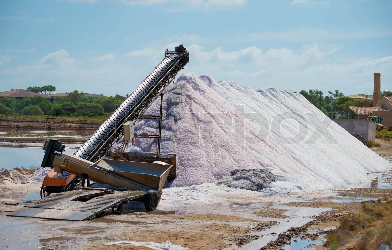 Sea salt production. The conveyor belt with salt. | Stock image | Colourbox