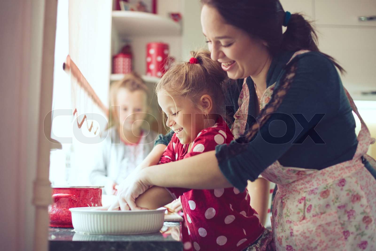 Mother with kids at the kitchen | Stock image | Colourbox