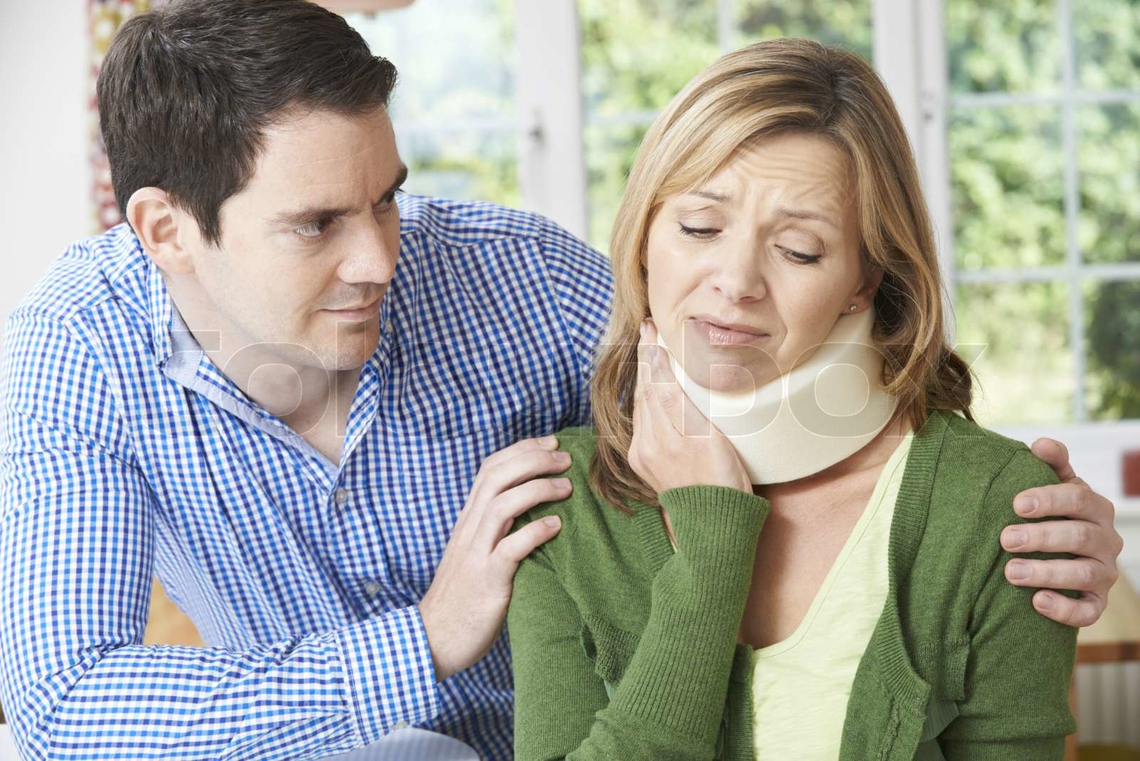 Husband Comforting Wife Suffering With Neck Injury | Stock image ...