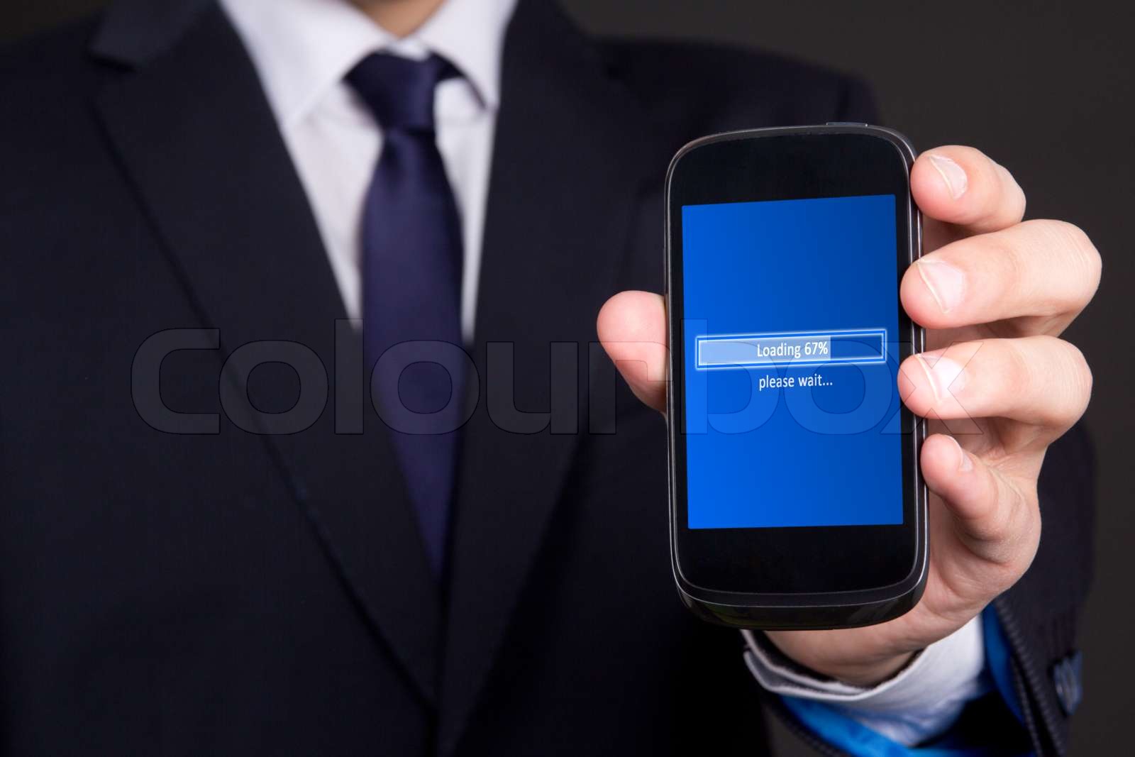 mobile phone loading in business man hand | Stock image | Colourbox