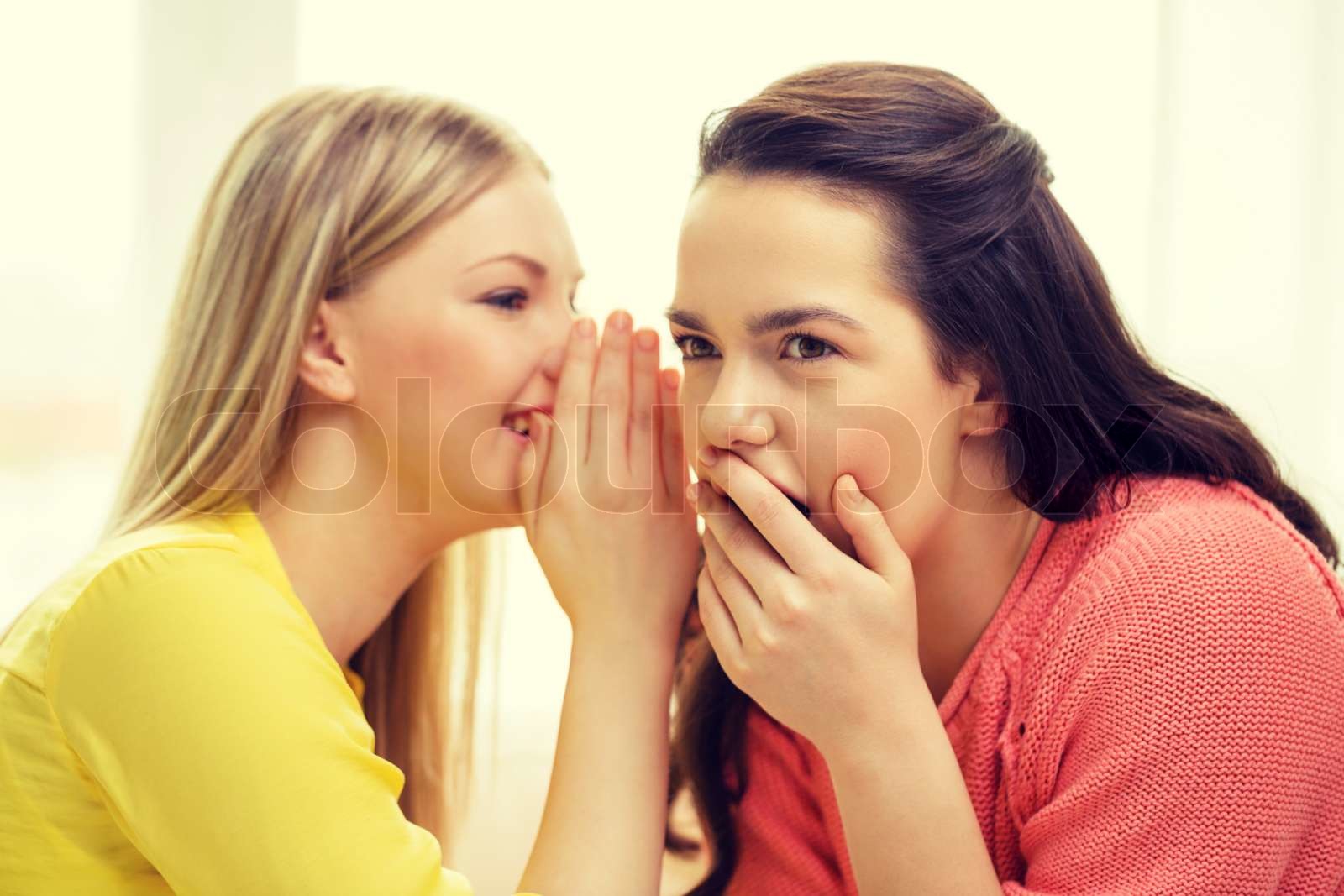 one girl telling another secret | Stock image | Colourbox