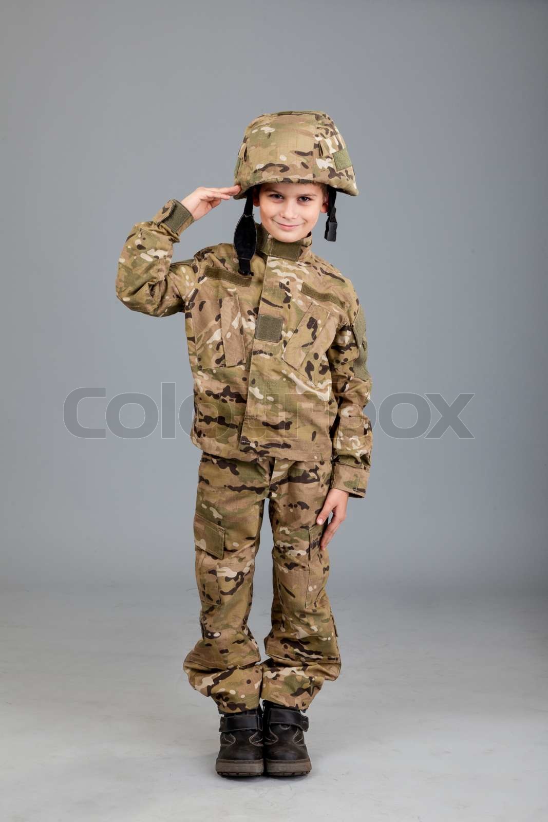 Saluting soldier. Young boy dressed like a soldier | Stock image ...