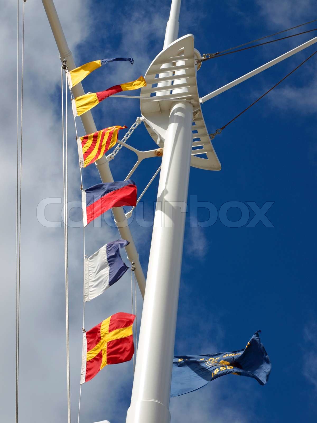 Nautical Flags Hanging from a Ship's Mast with Wispy Clouds | Stock ...