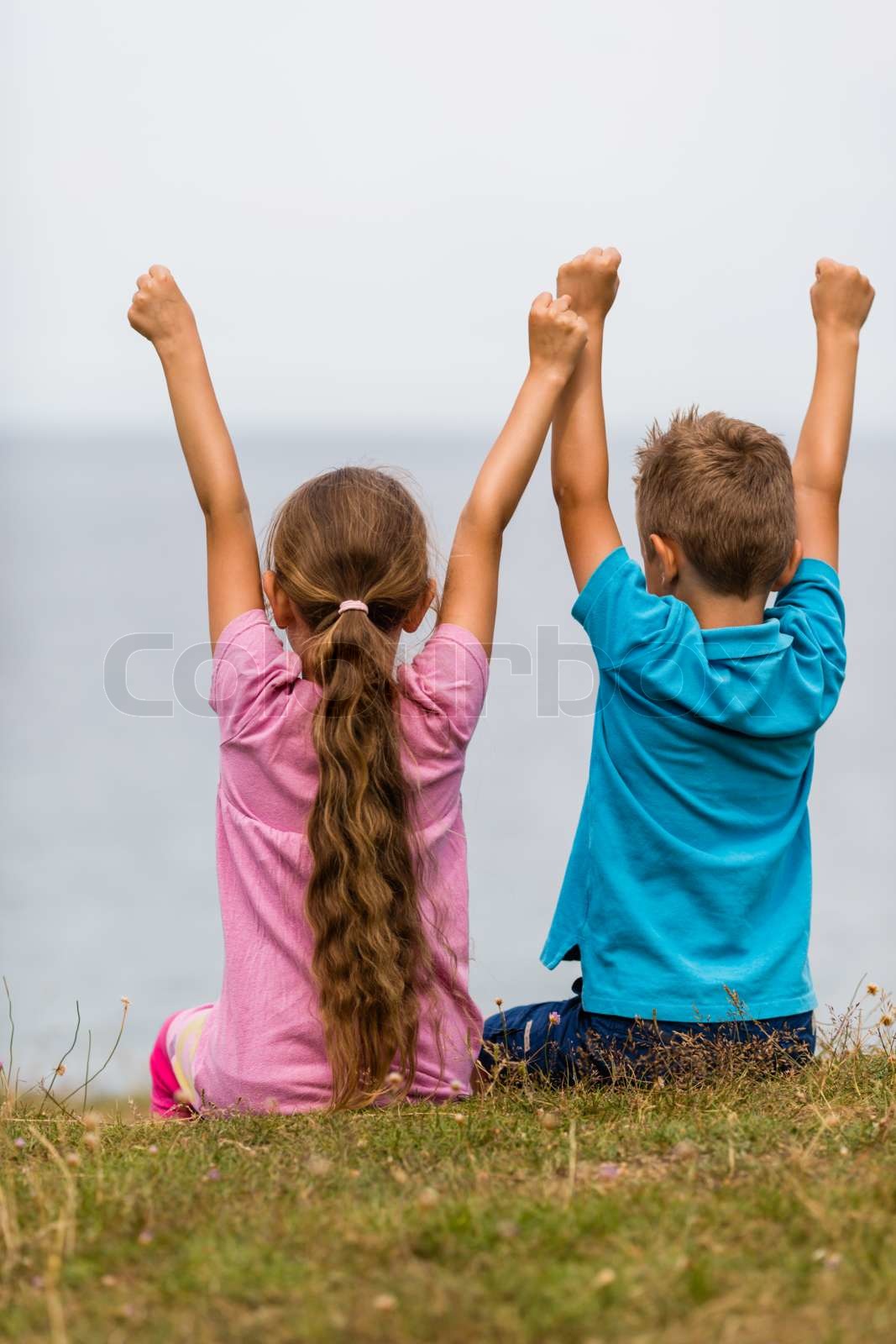 Kids with raised arms | Stock image | Colourbox
