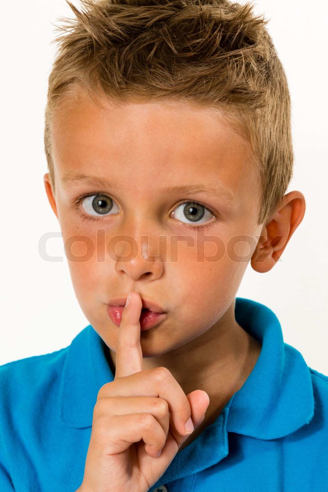 Boy making keep quiet gesture | Stock image | Colourbox