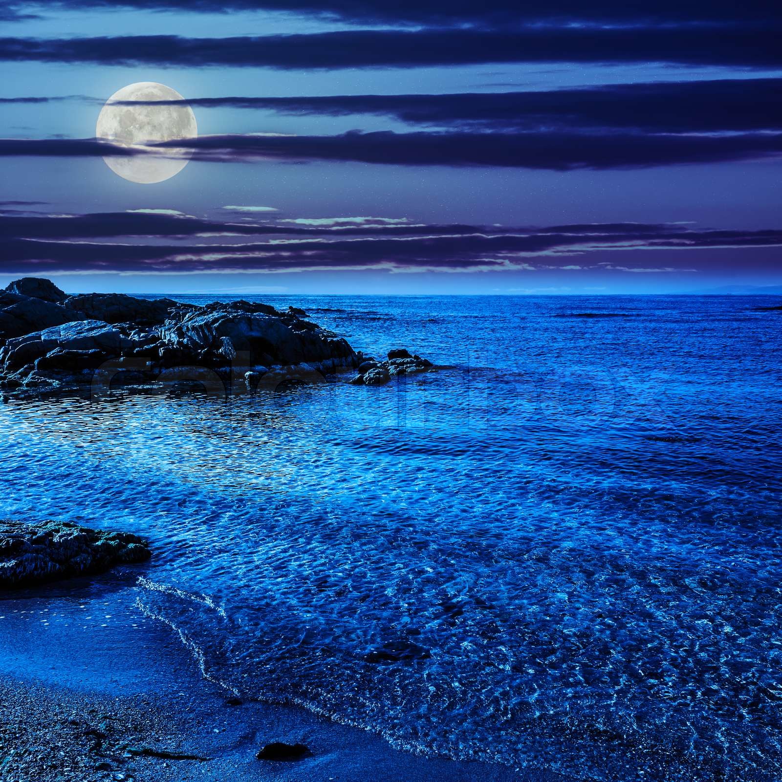 calm sea with waves on sandy beach at night | Stock image | Colourbox