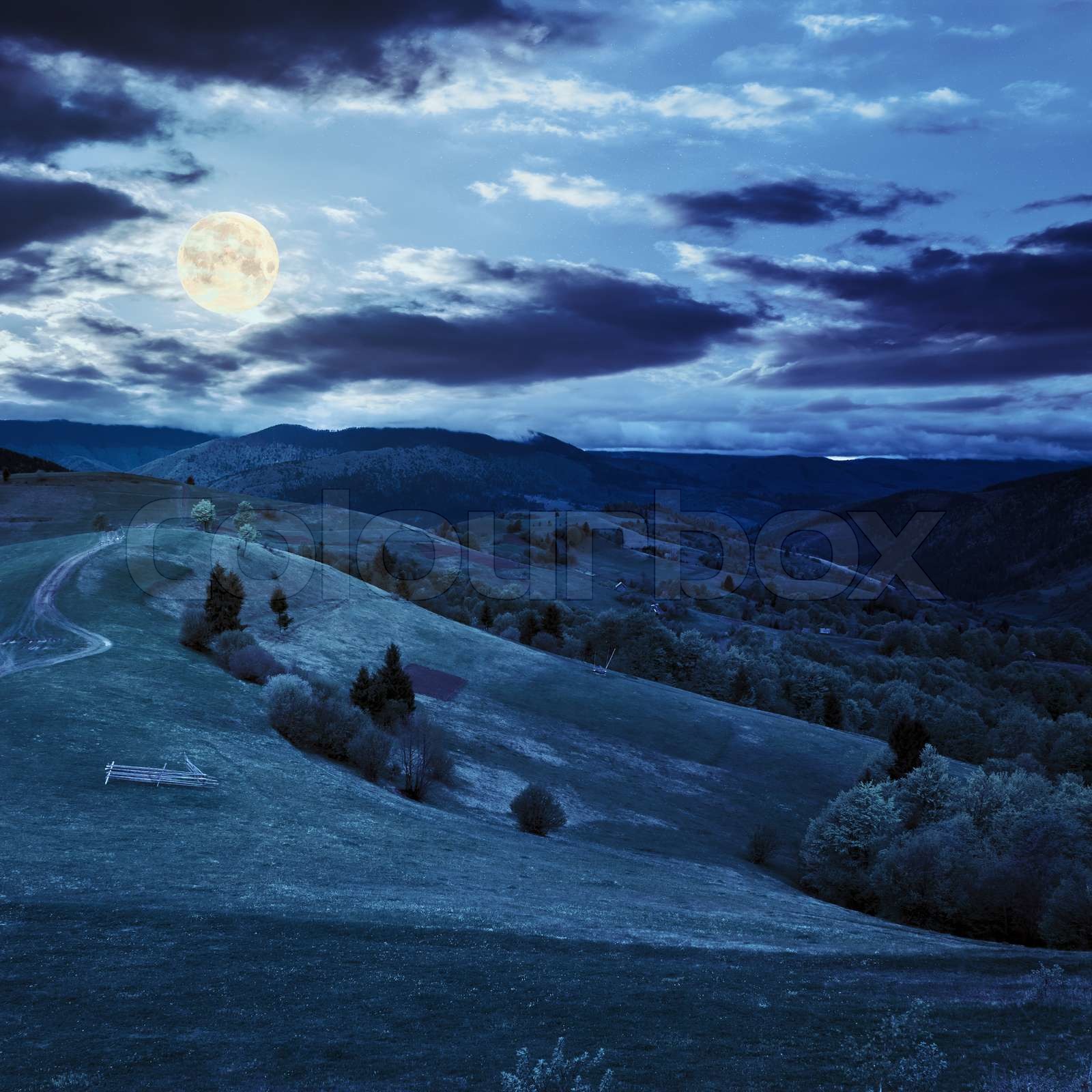 fence on hillside meadow at night | Stock image | Colourbox