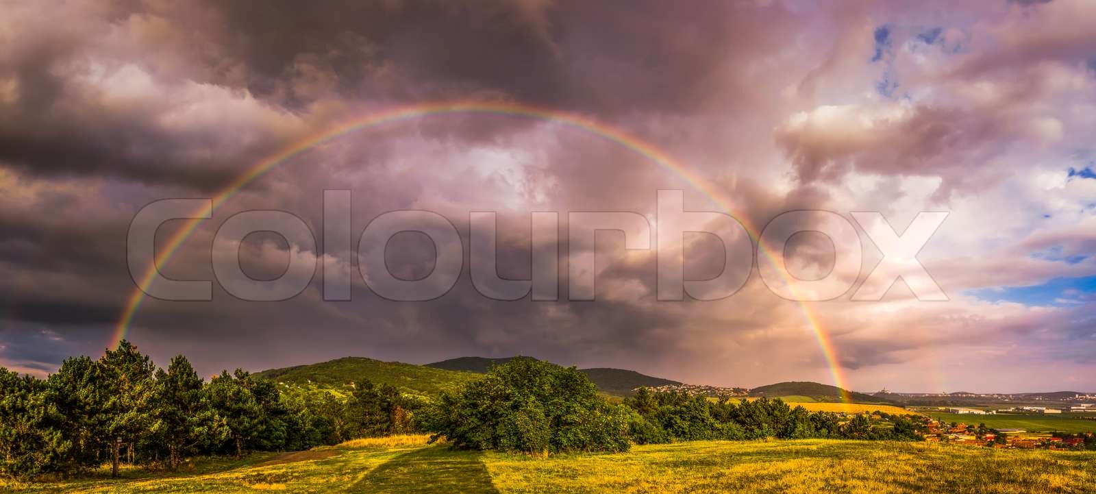 Rainbow over Landscape at Sunset | Stock image | Colourbox