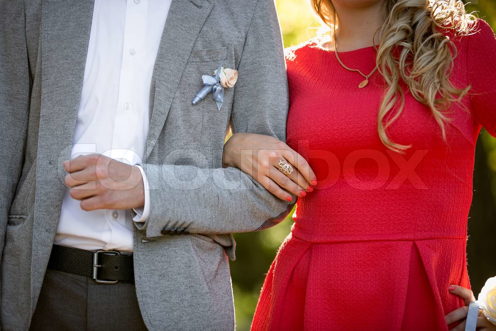 young woman holding boyfriends arm | Stock image | Colourbox