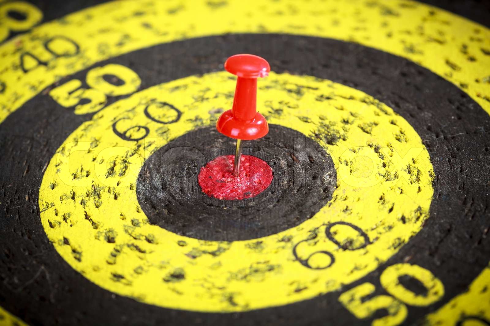 Red Pin Placed in the Center of Old Target | Stock image | Colourbox