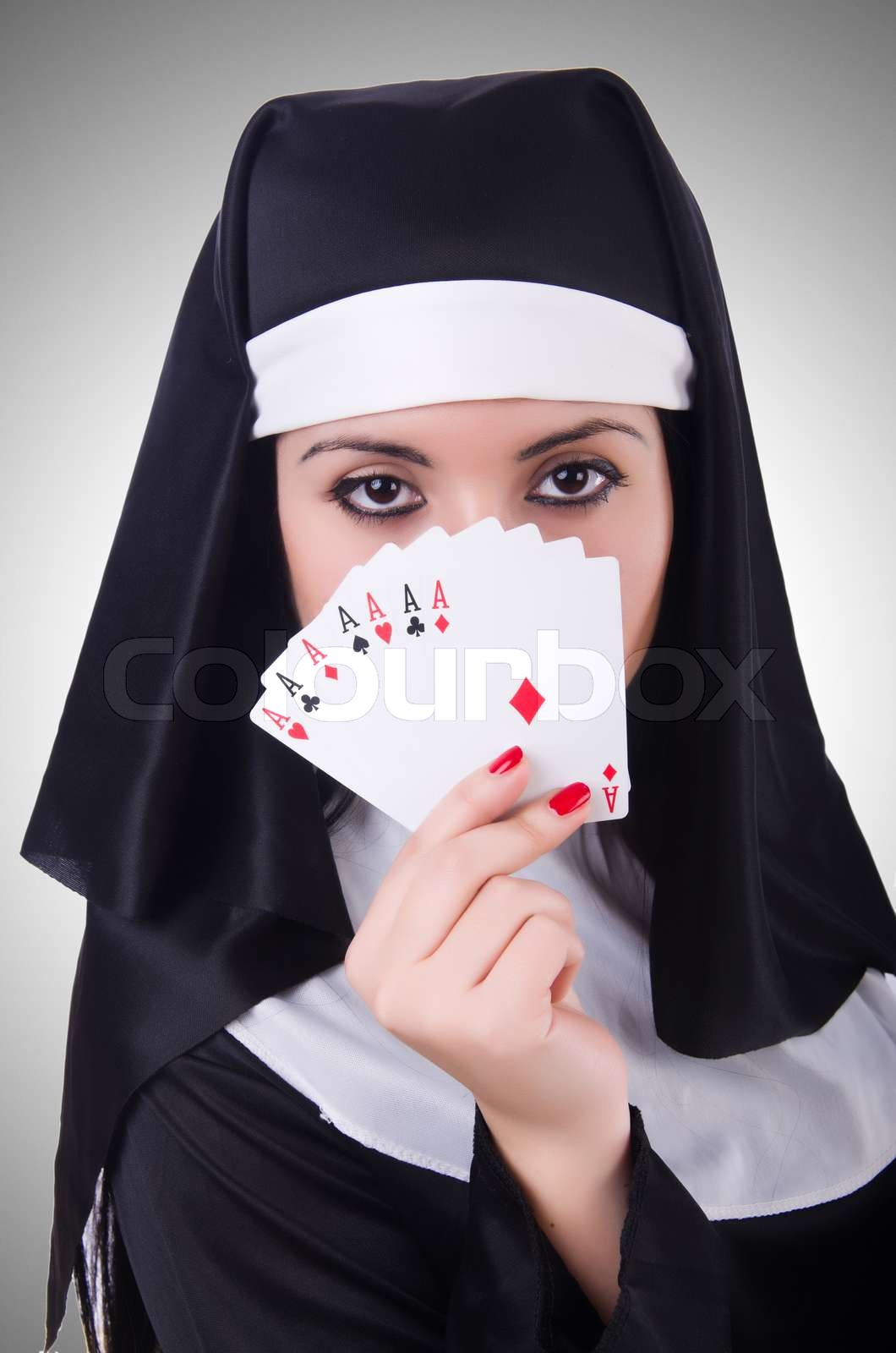 Nun playing cards on white | Stock image | Colourbox