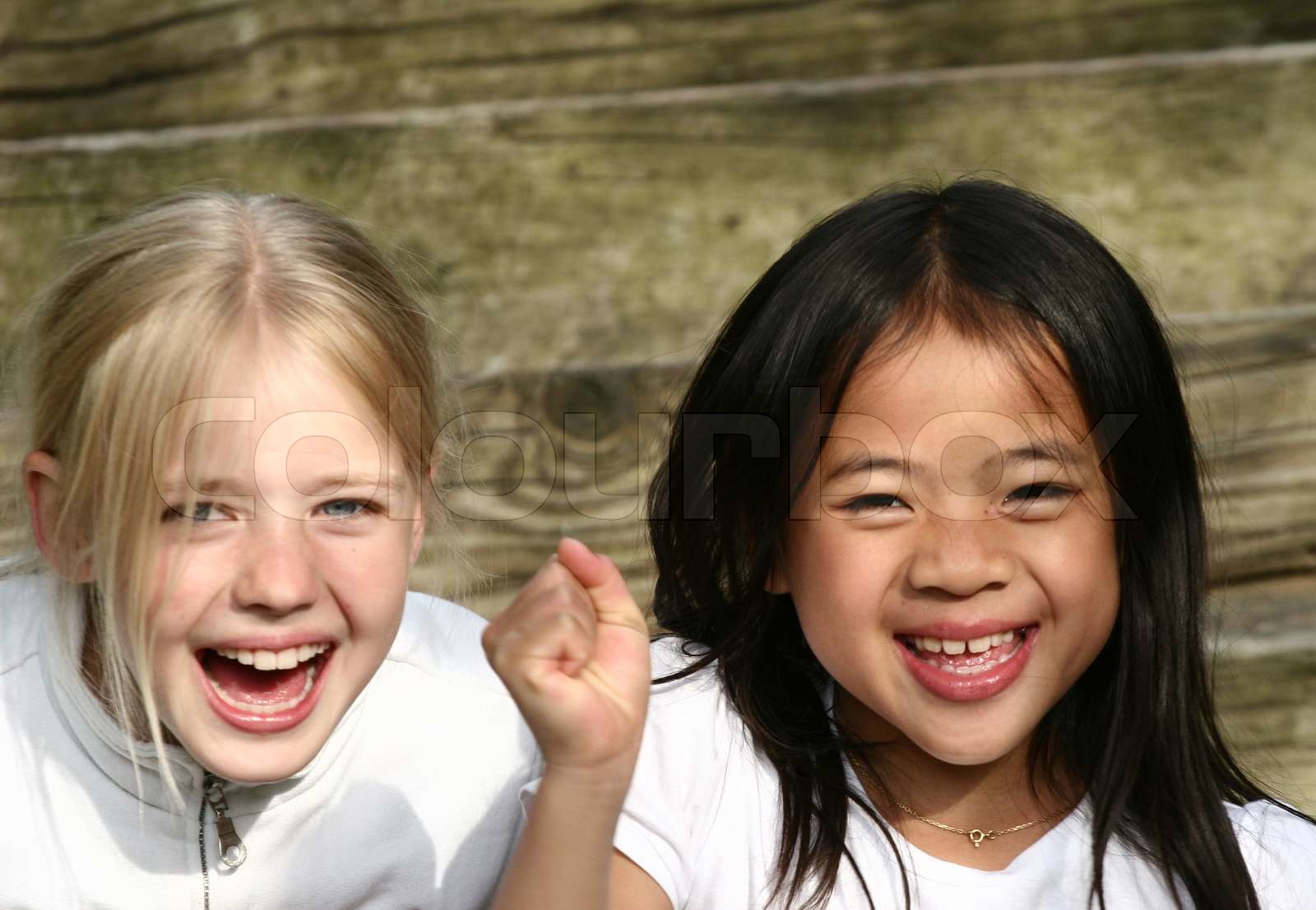 Close up of face of happy children while smiling /laughing and playing ...