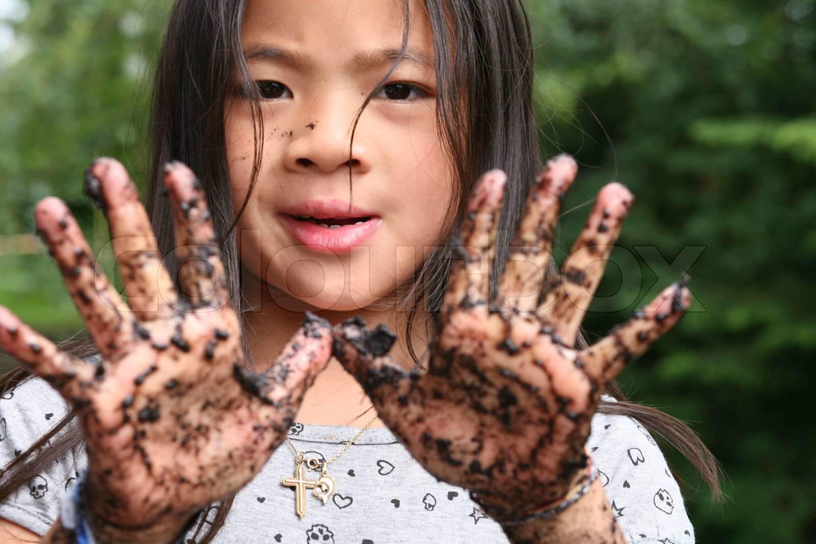 close up of child showing two dirty hands | Stock image | Colourbox