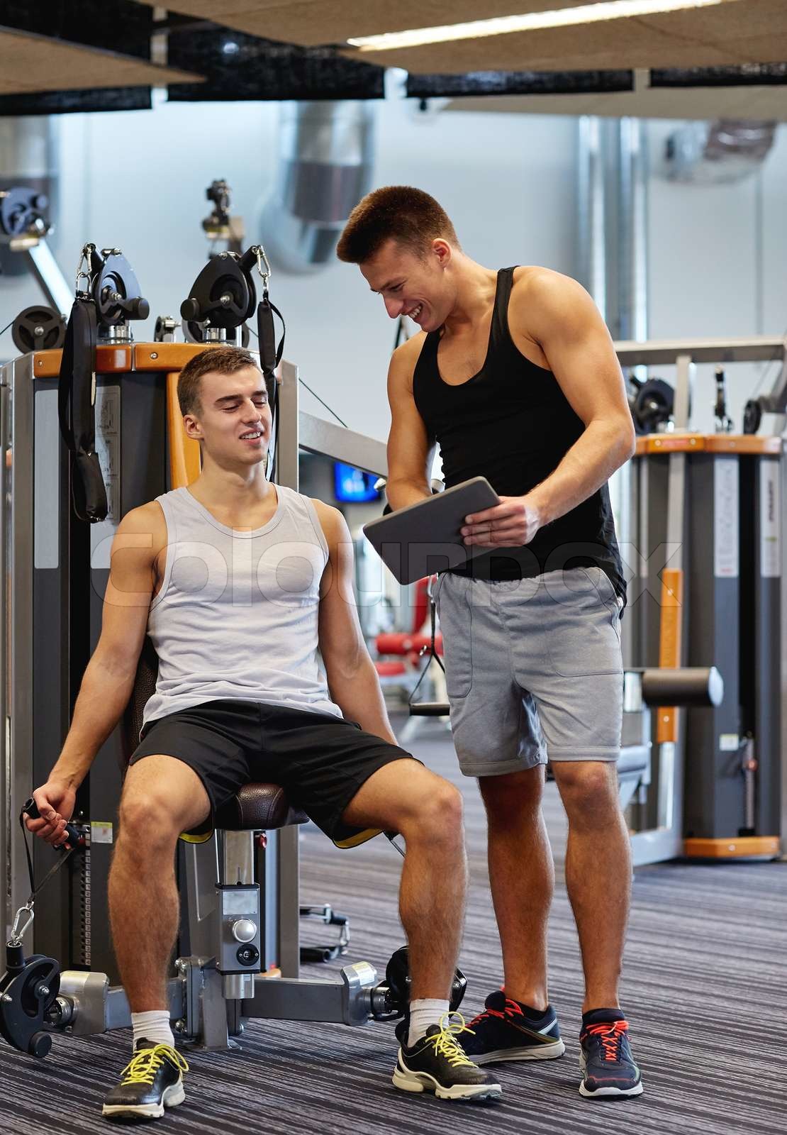 men exercising on gym machine | Stock image | Colourbox