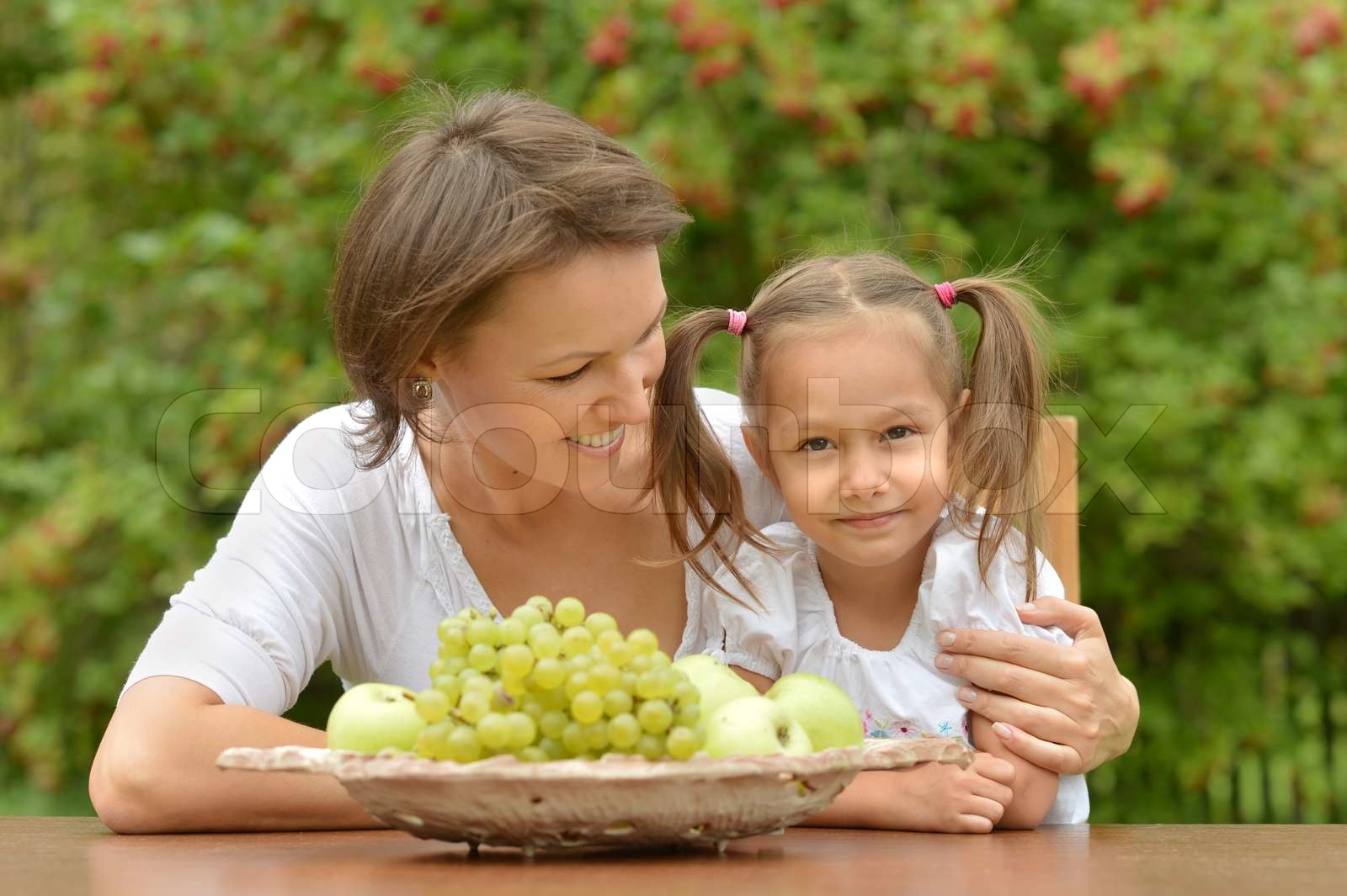 Mother and daughter with fruits | Stock image | Colourbox