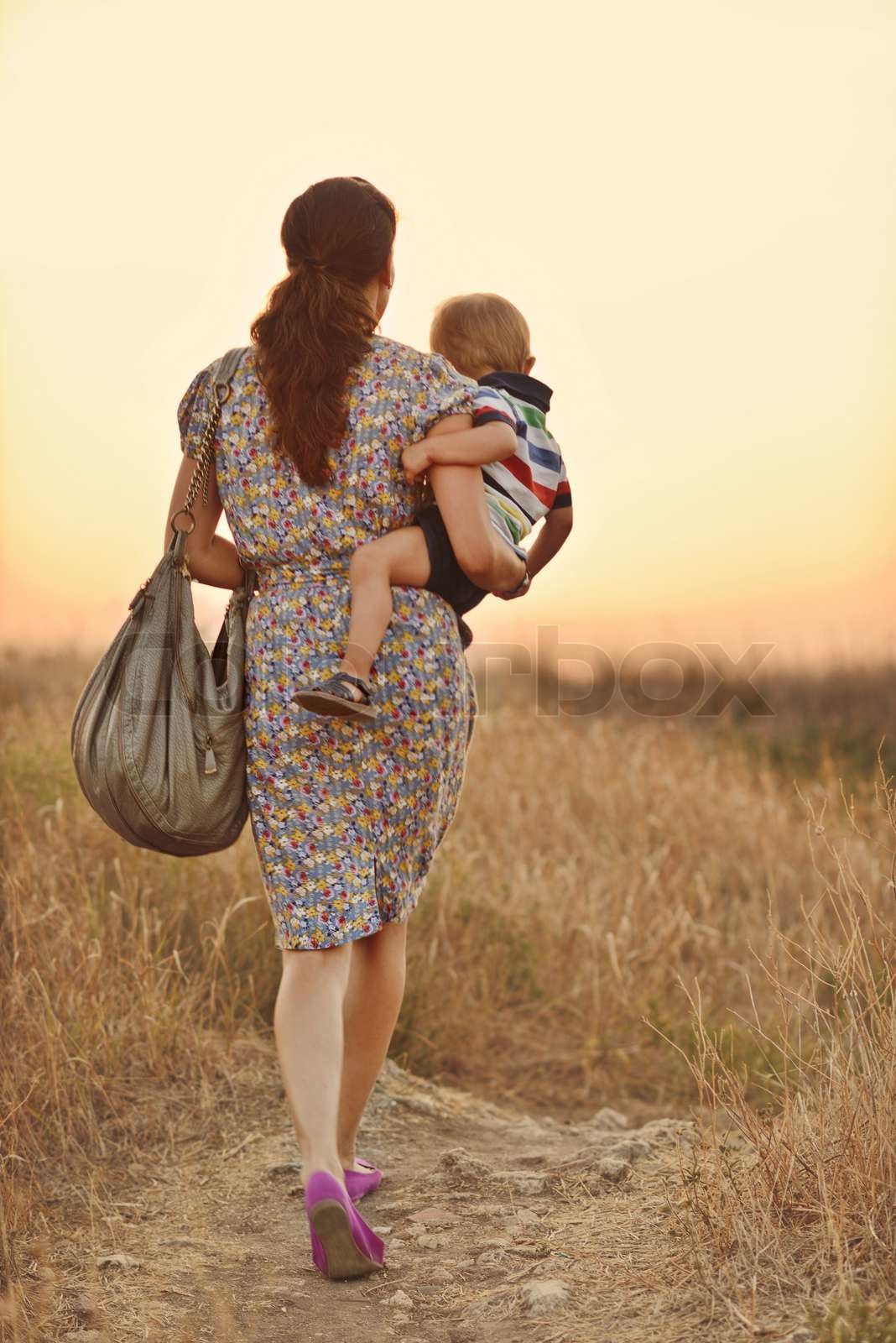 mother carrying son | Stock image | Colourbox