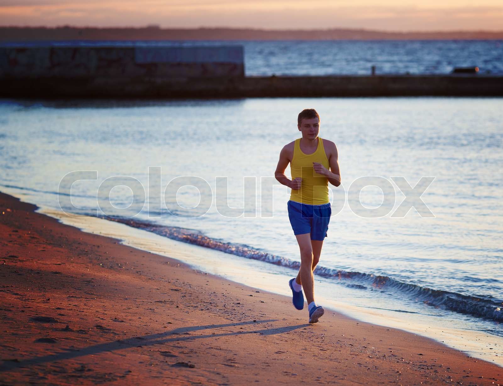 Man running on the beach | Stock image | Colourbox