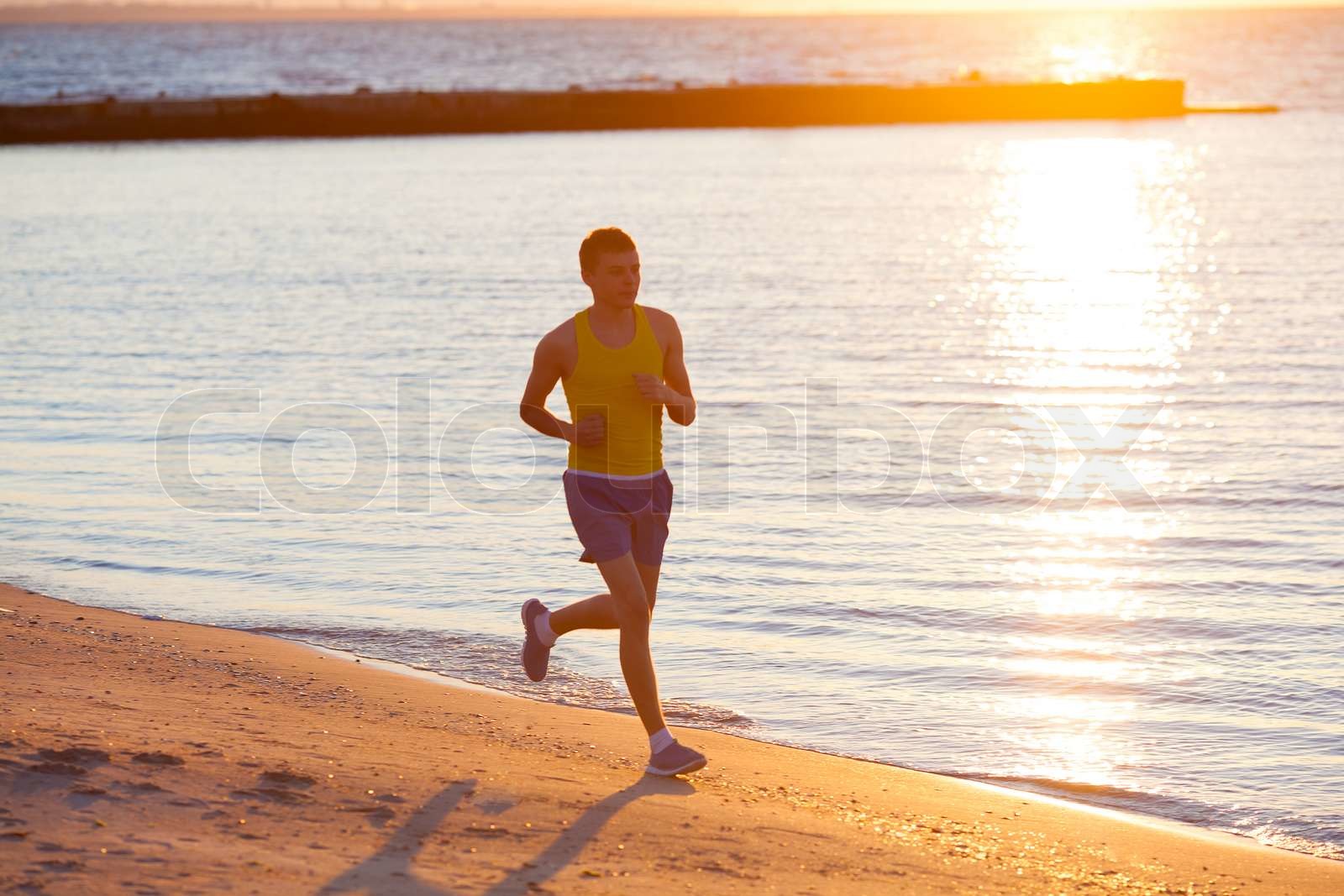 Man running on the beach | Stock image | Colourbox
